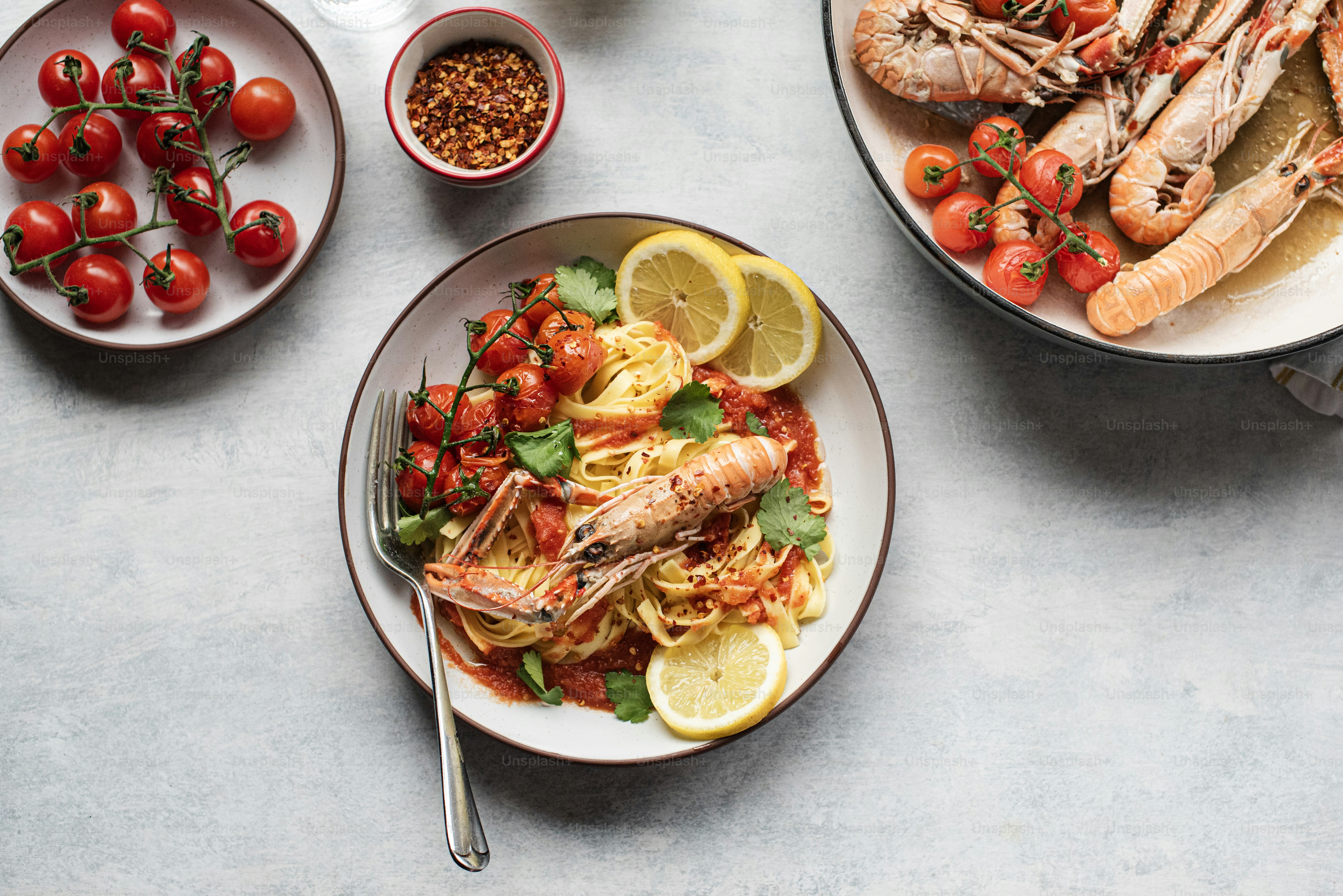 A table topped with plates of food and bowls of food photo – Food ...