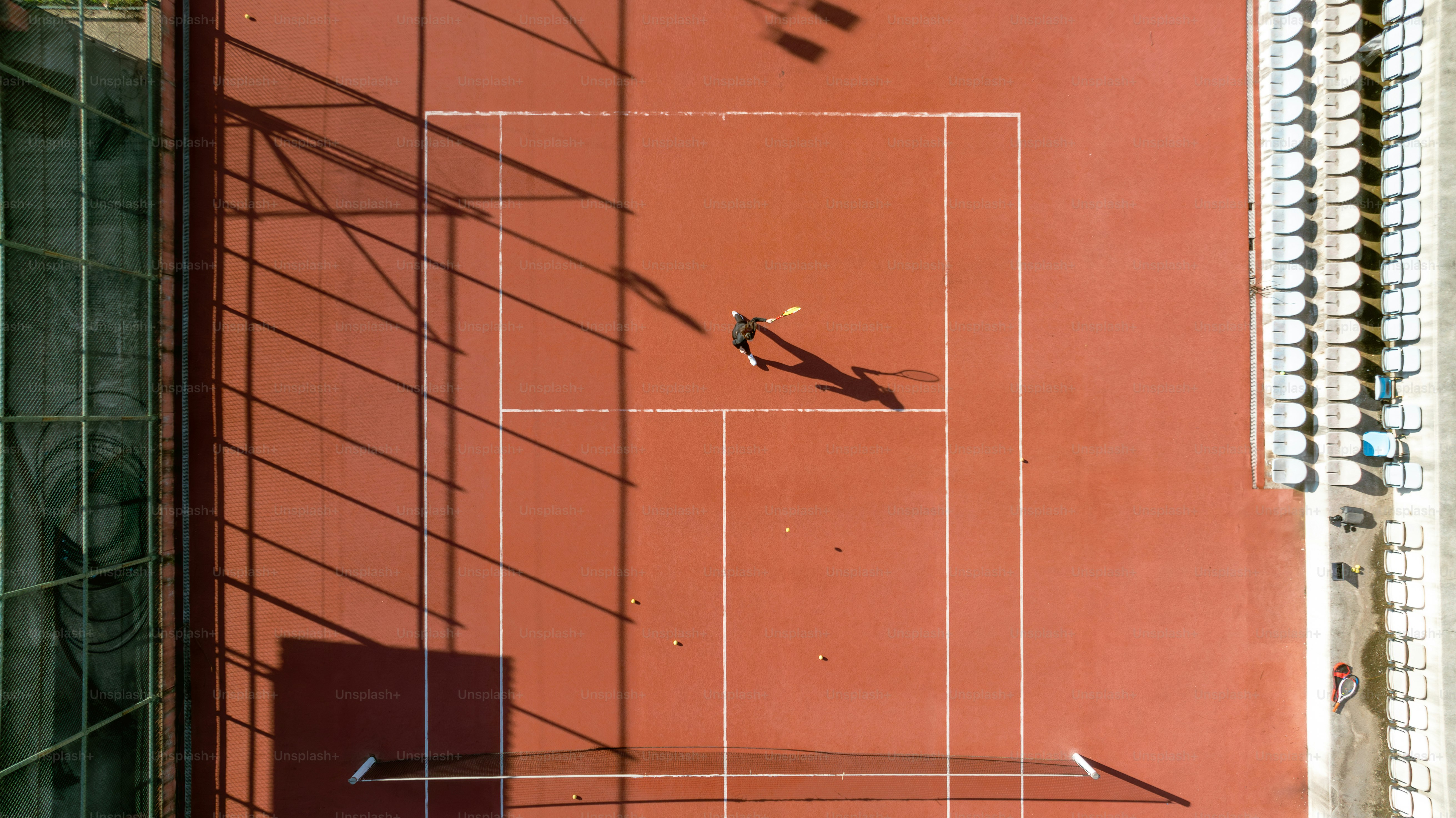A couple of people standing on a tennis court holding racquets photo ...
