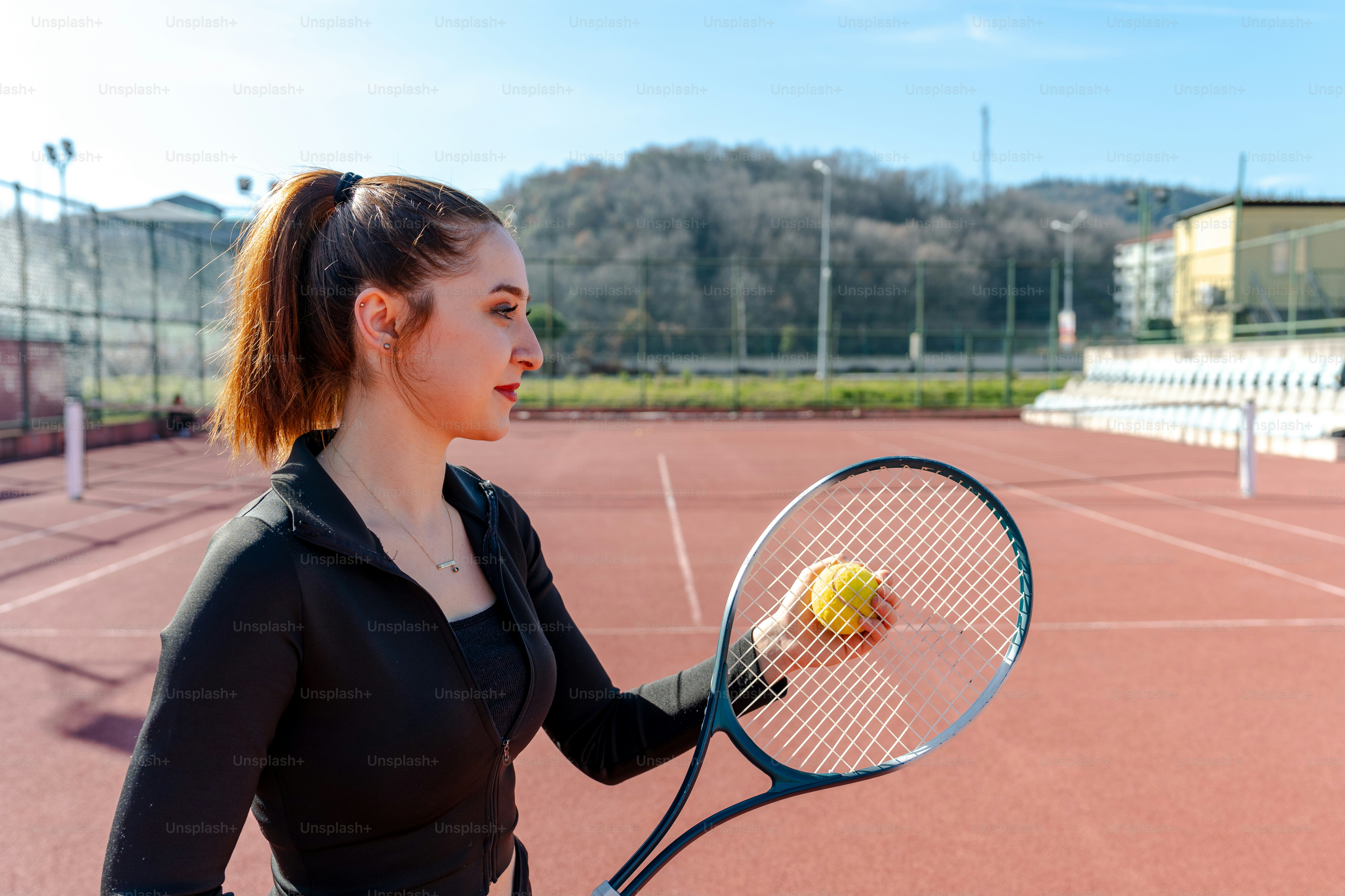 A woman holding a tennis racket and a tennis ball photo – Racket sports ...