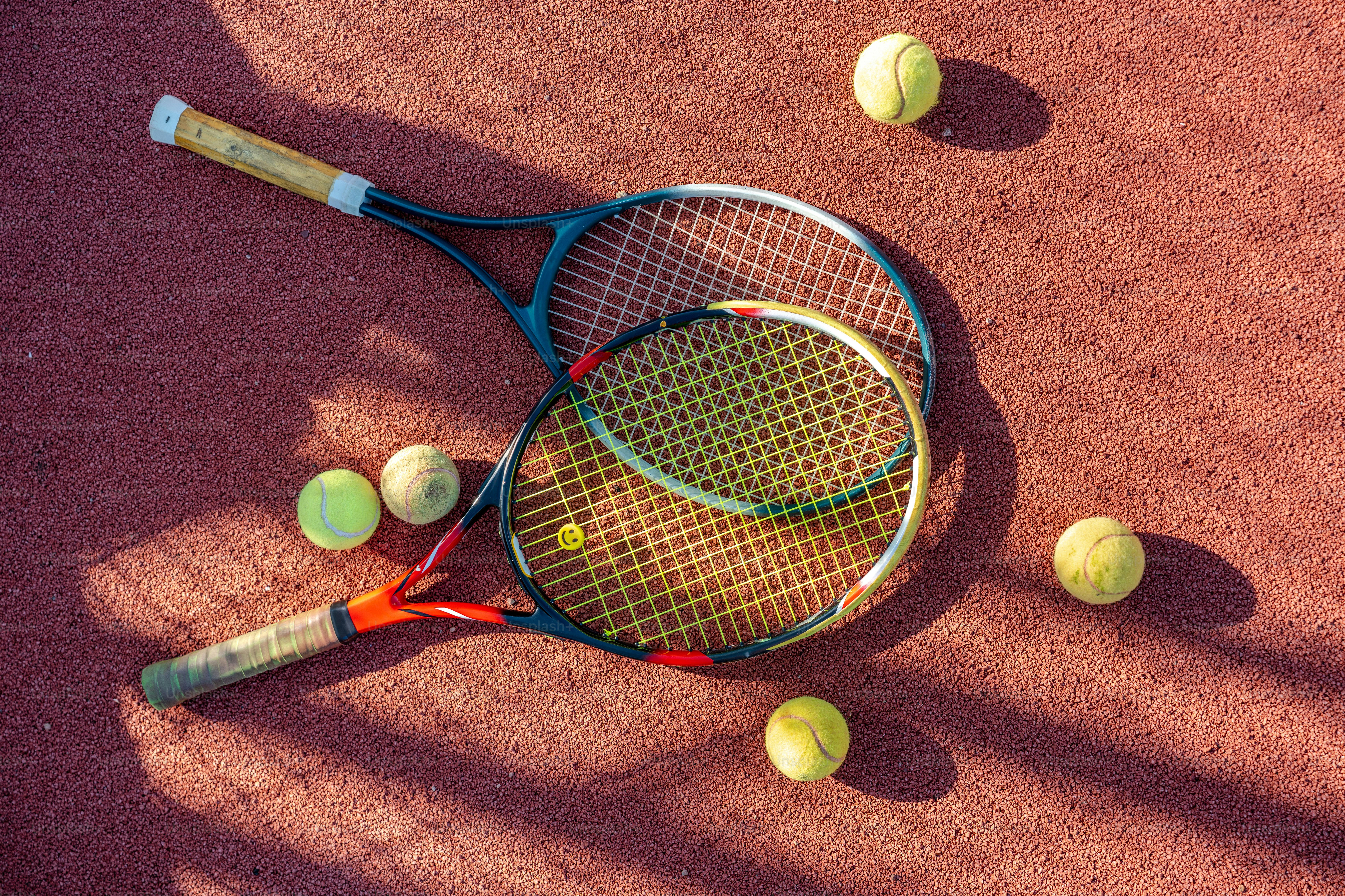 A tennis racket and tennis balls on a tennis court photo – Racket ...
