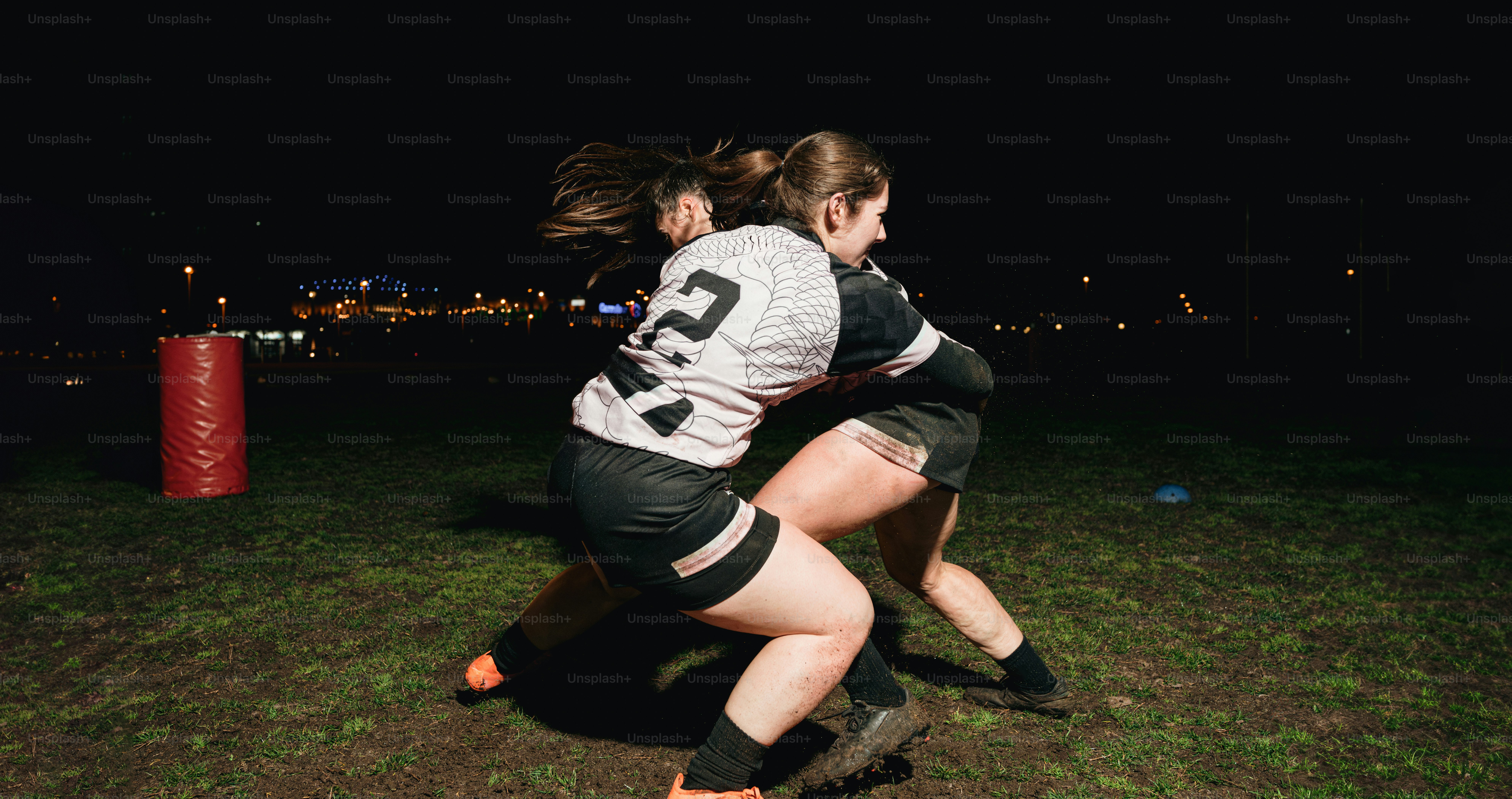 Two women playing a game of frisbee at night photo – Tackle Image on ...
