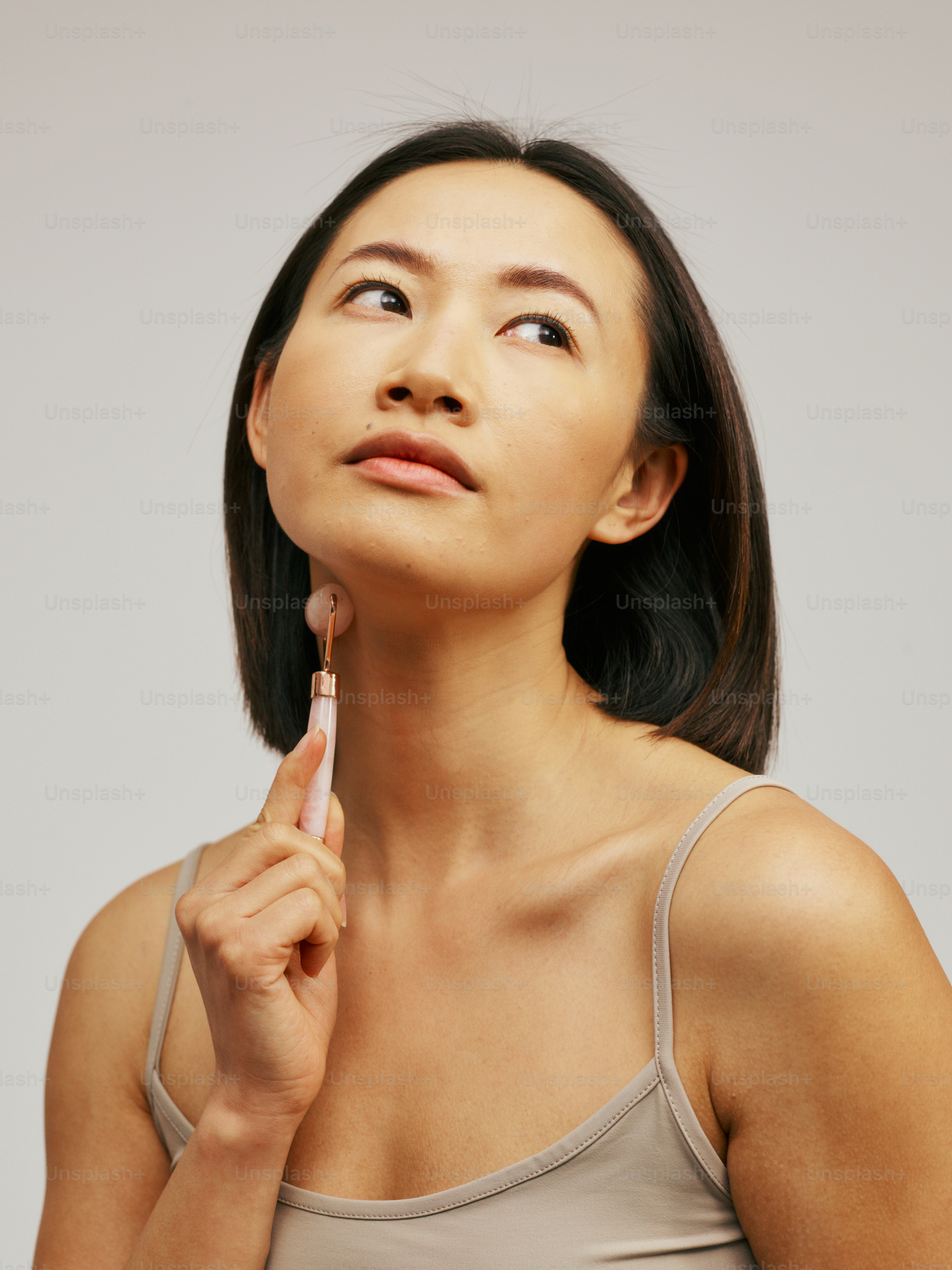 A woman holding a toothbrush up to her face photo – Skin Image on Unsplash