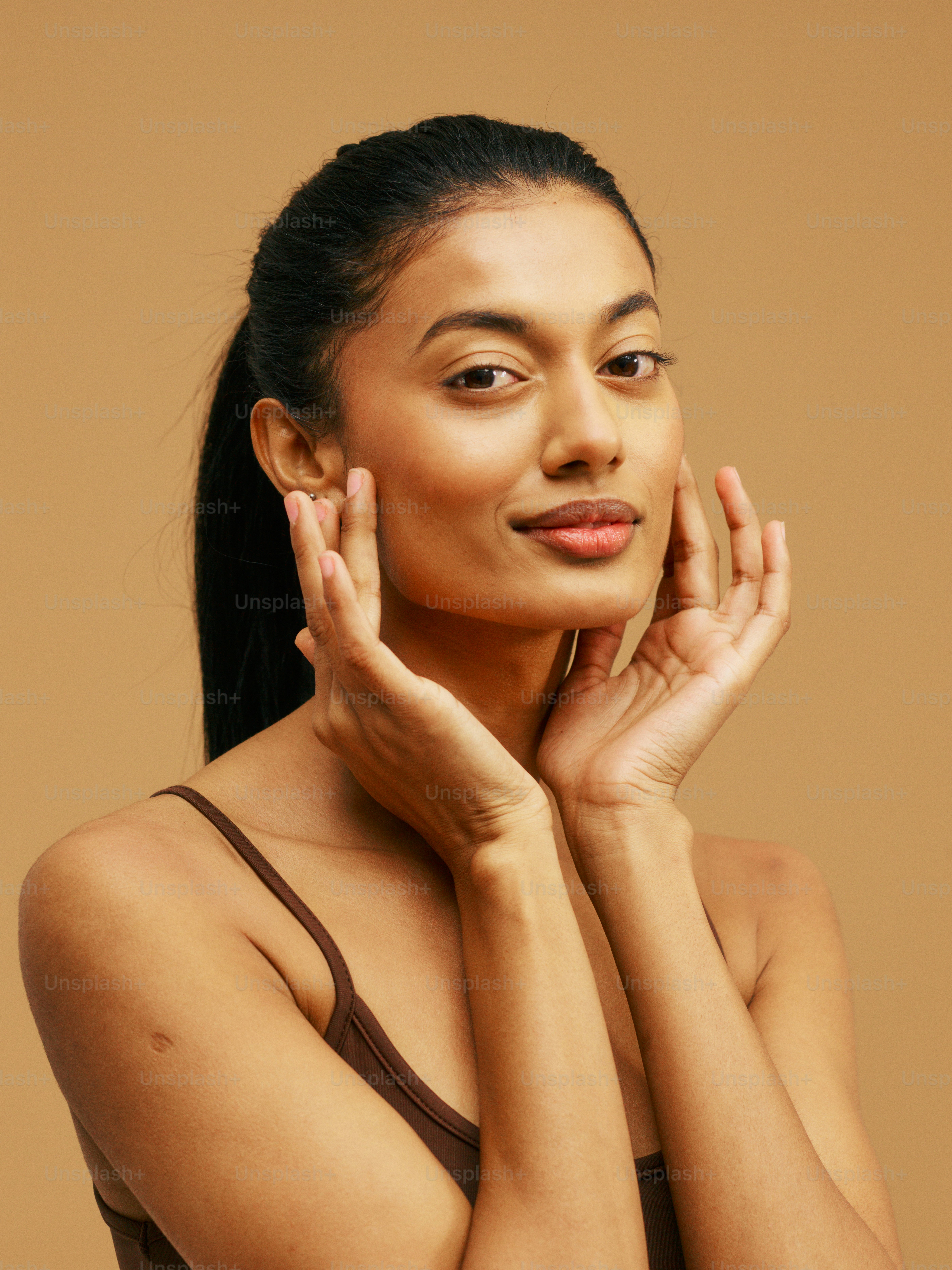 A woman posing with her hands on her face photo – Woman Image on Unsplash