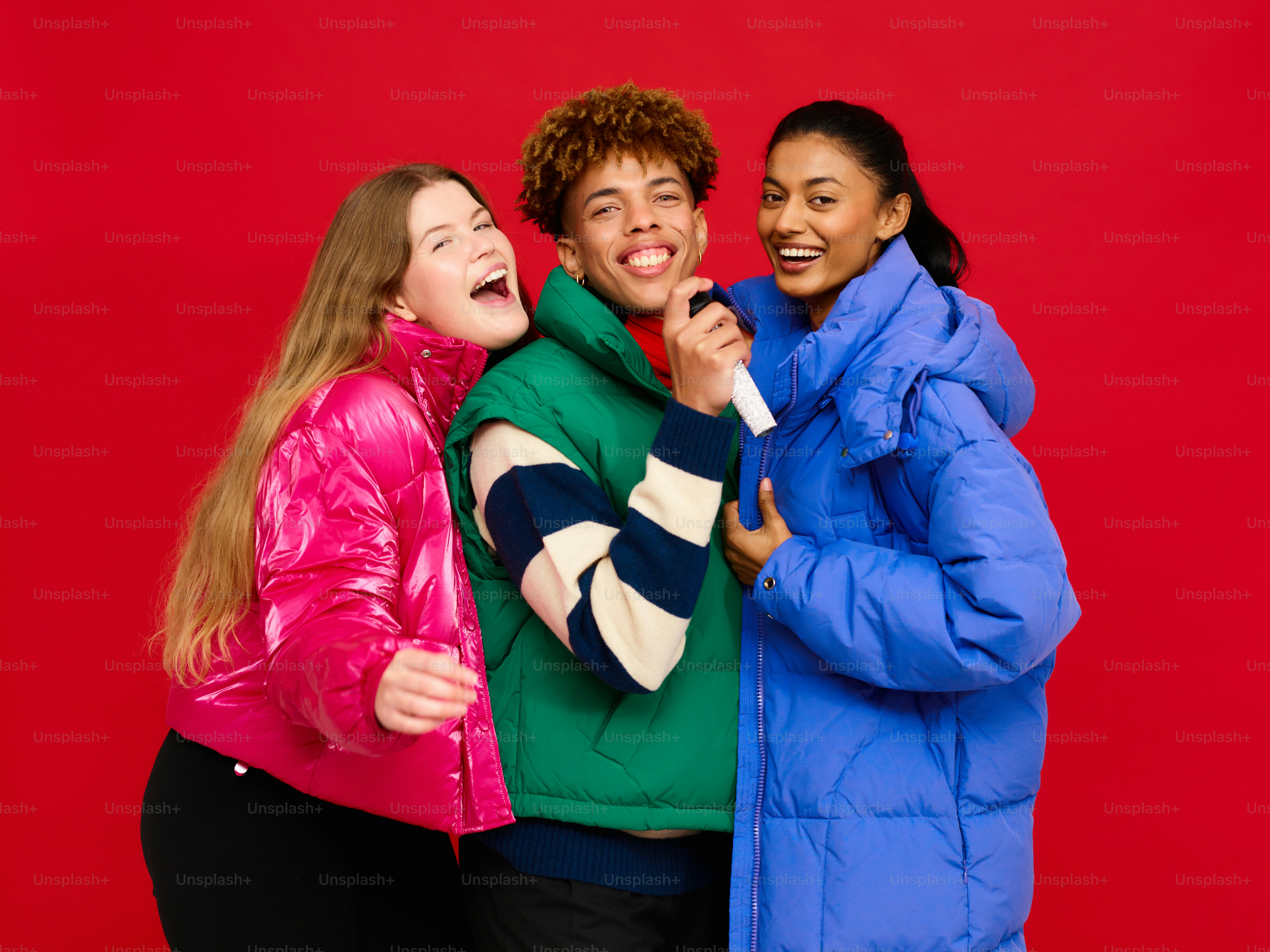 A group of three people standing next to each other photo – Karaoke ...