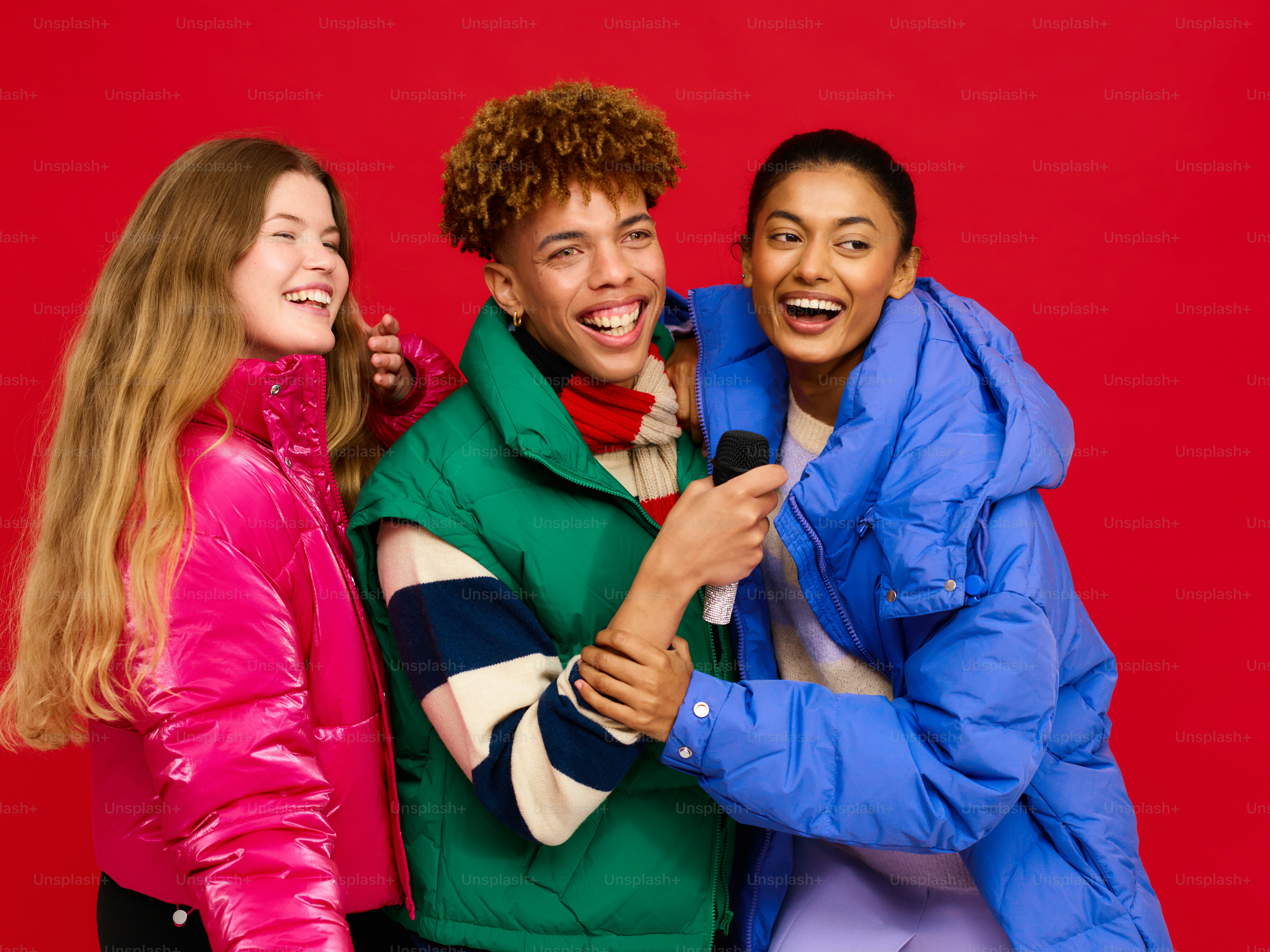 A group of three people standing next to each other photo – Karaoke ...