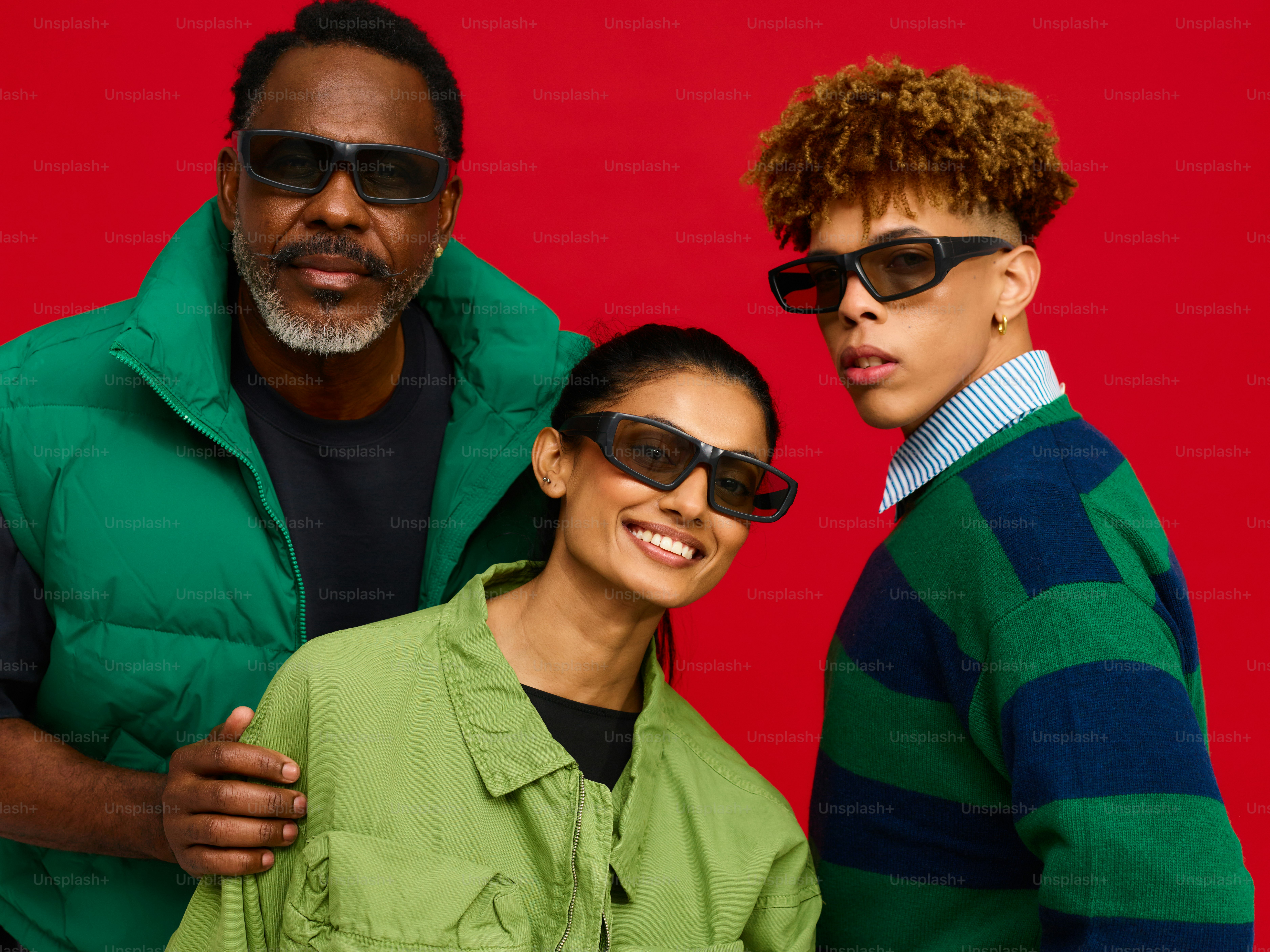 A group of three people standing next to each other photo – Male and ...