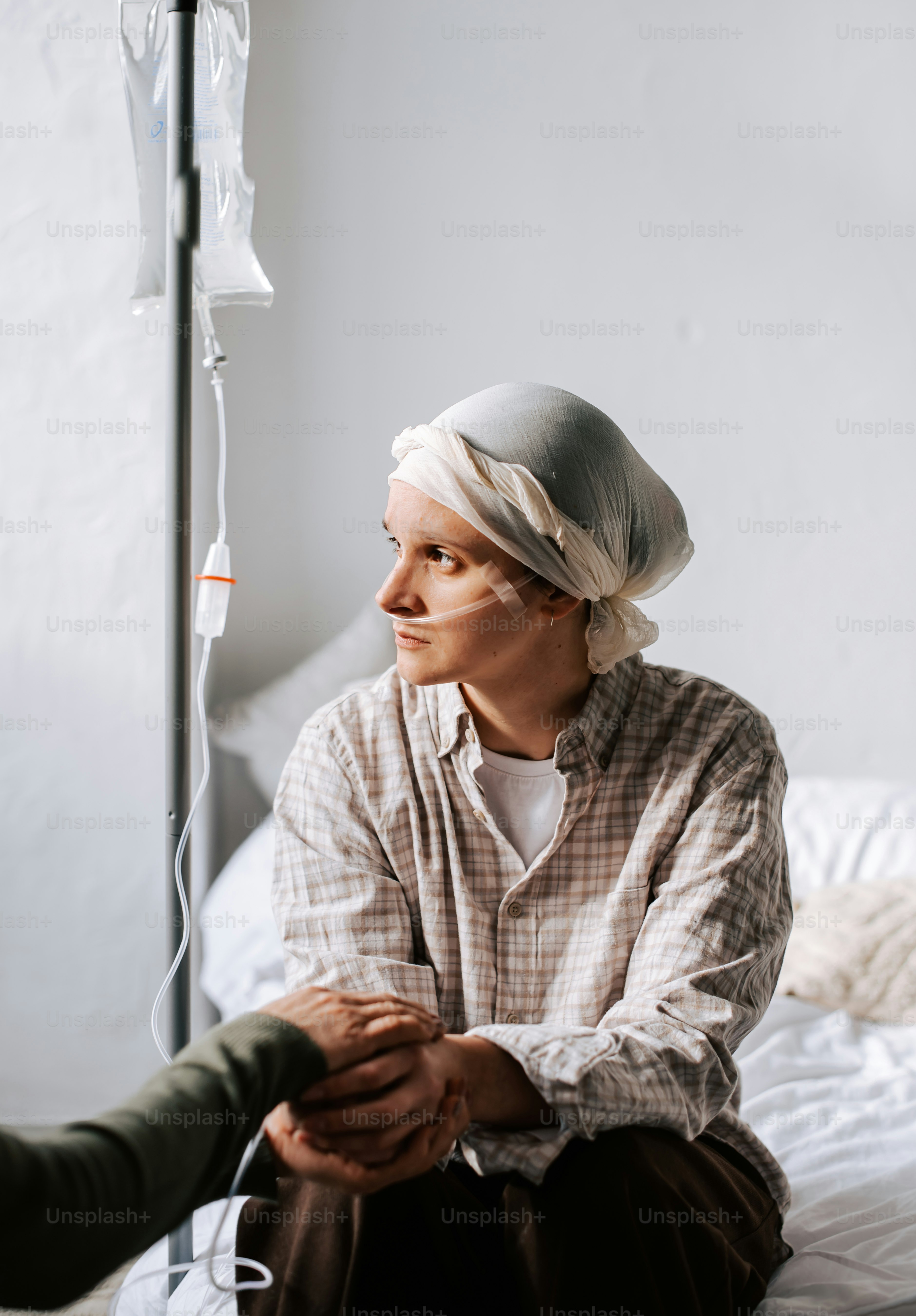 A woman sitting on top of a bed next to a man photo – Chemo Image on ...