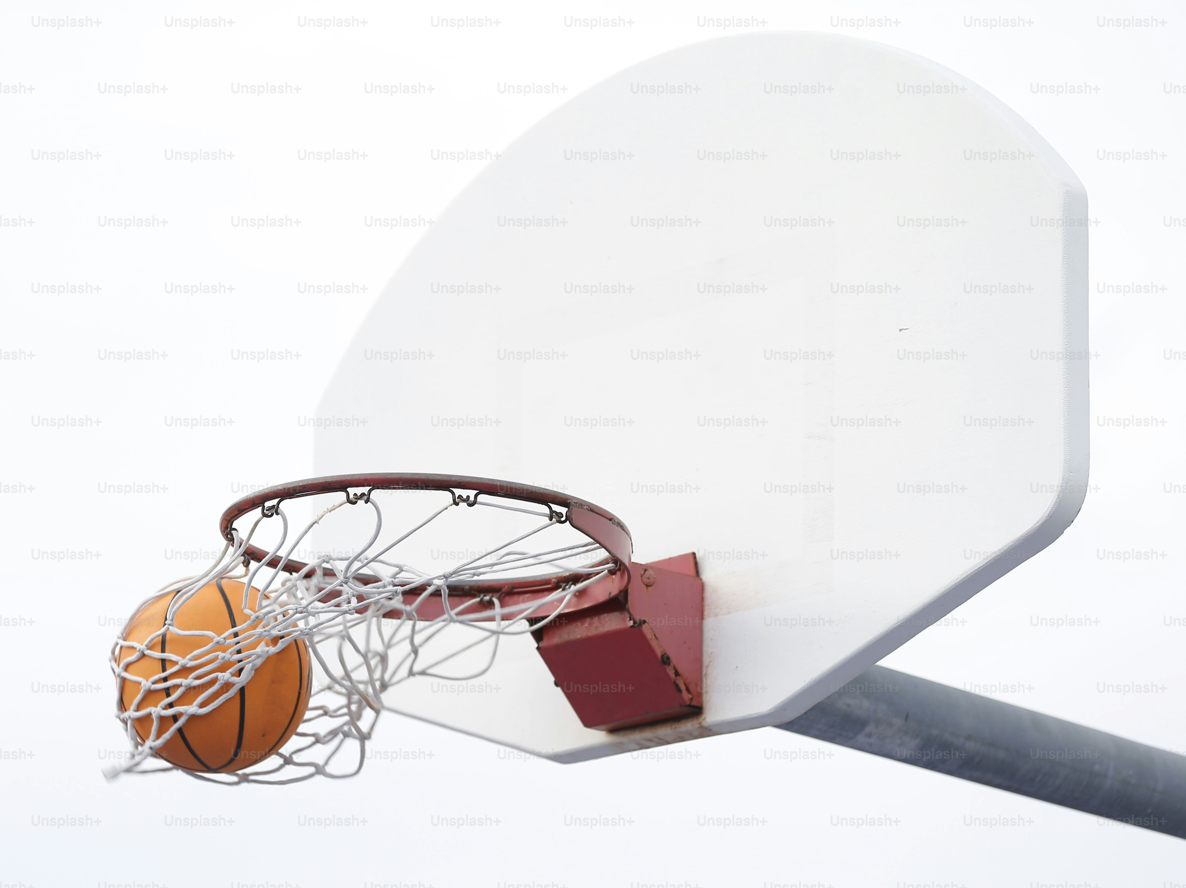 A basketball going through a hoop with a basketball in it photo ...
