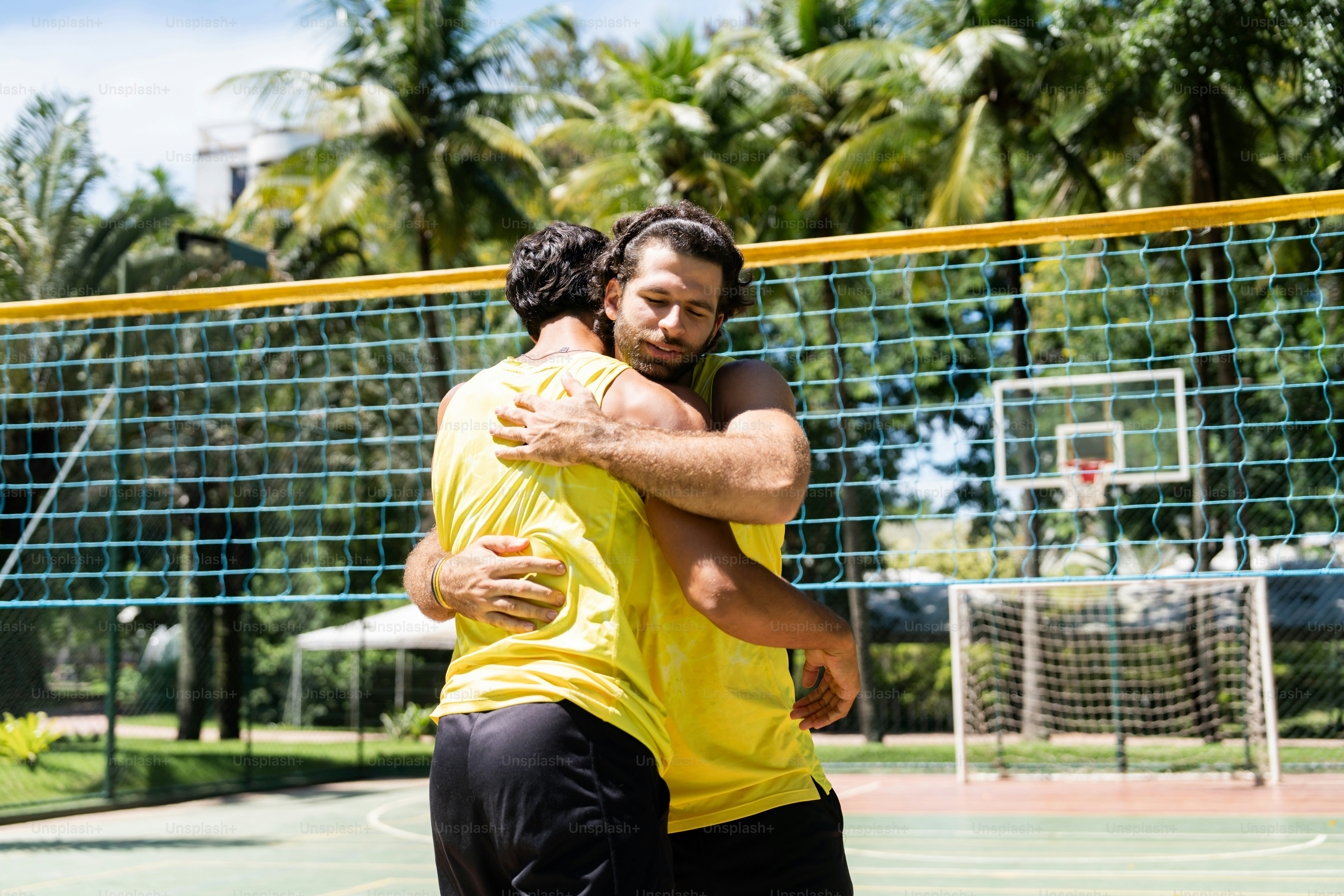 Two men hugging each other on a tennis court photo – Sport Image on ...