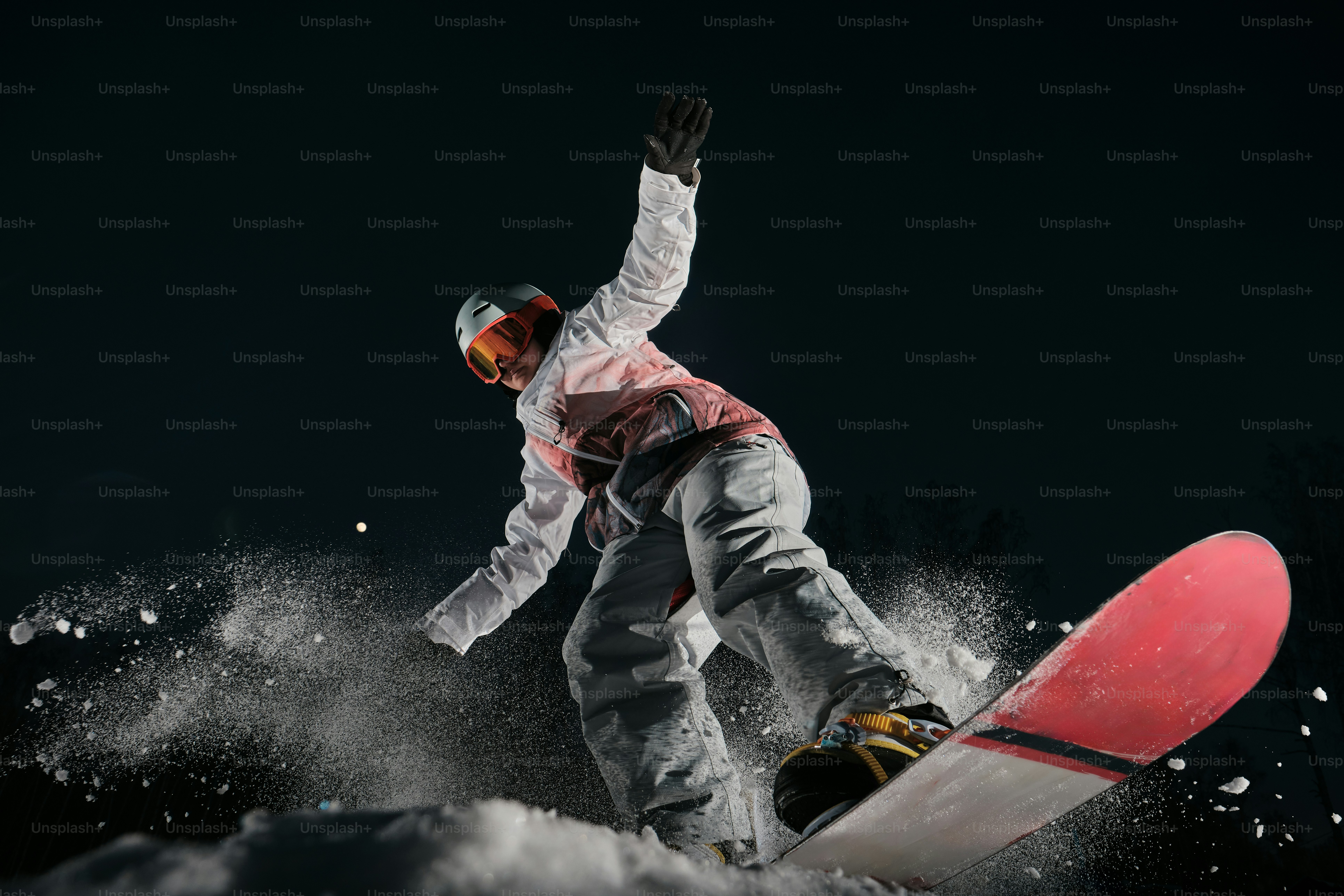 A man riding a snowboard down a snow covered slope photo – Snow Image ...