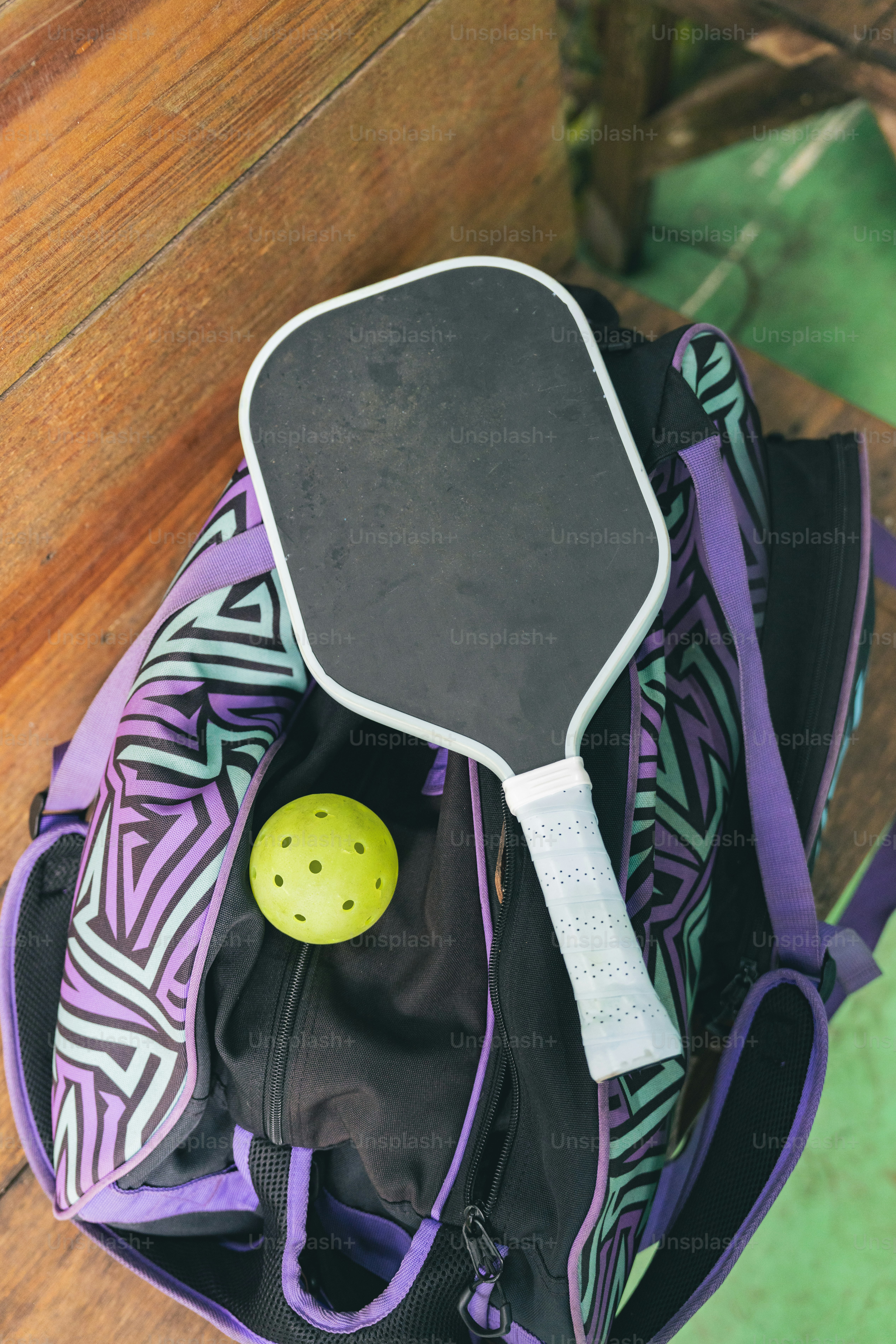 A man holding a tennis racquet and a ping pong paddle photo – Sports ...