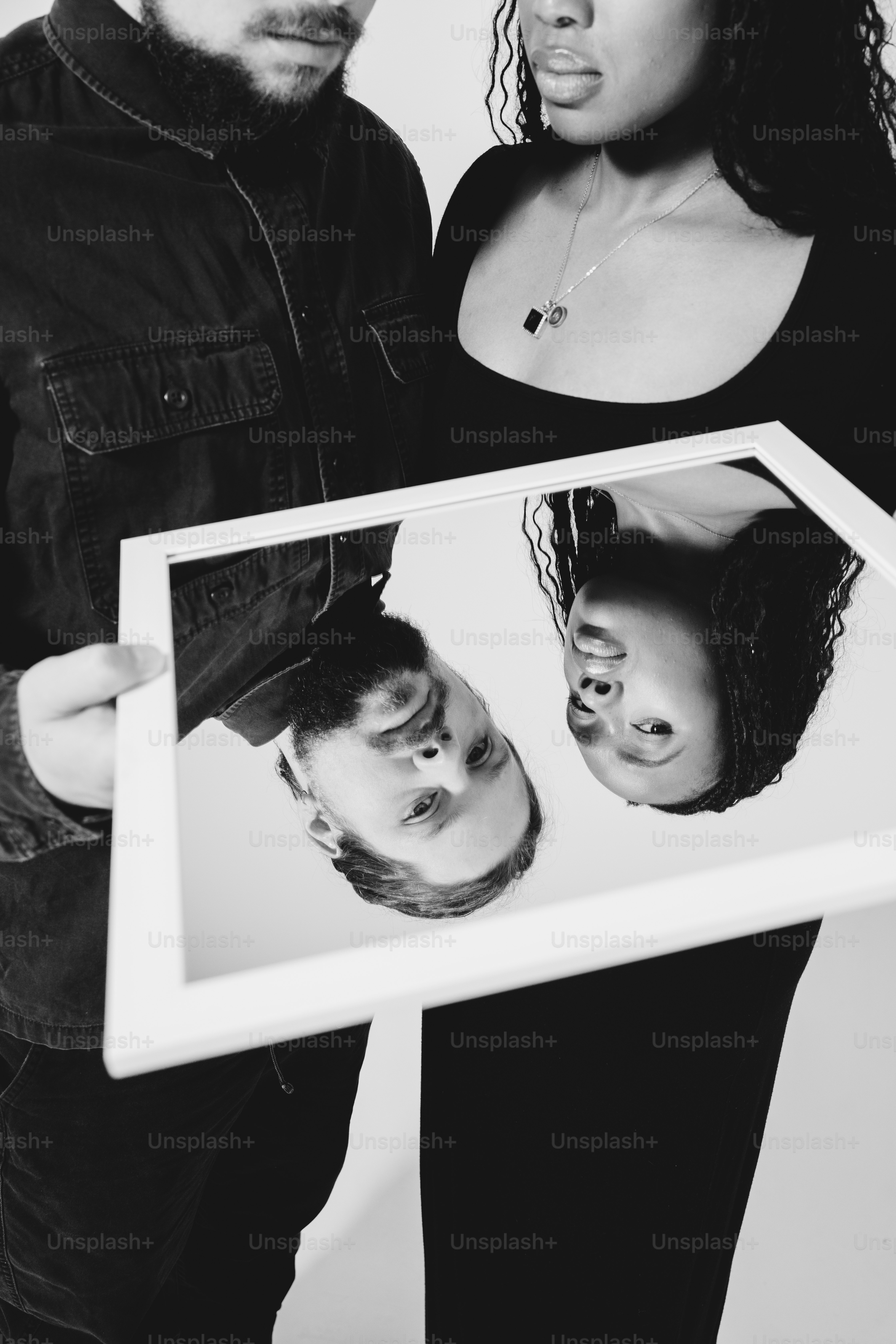A woman holding a colorful cube in front of her face photo ...