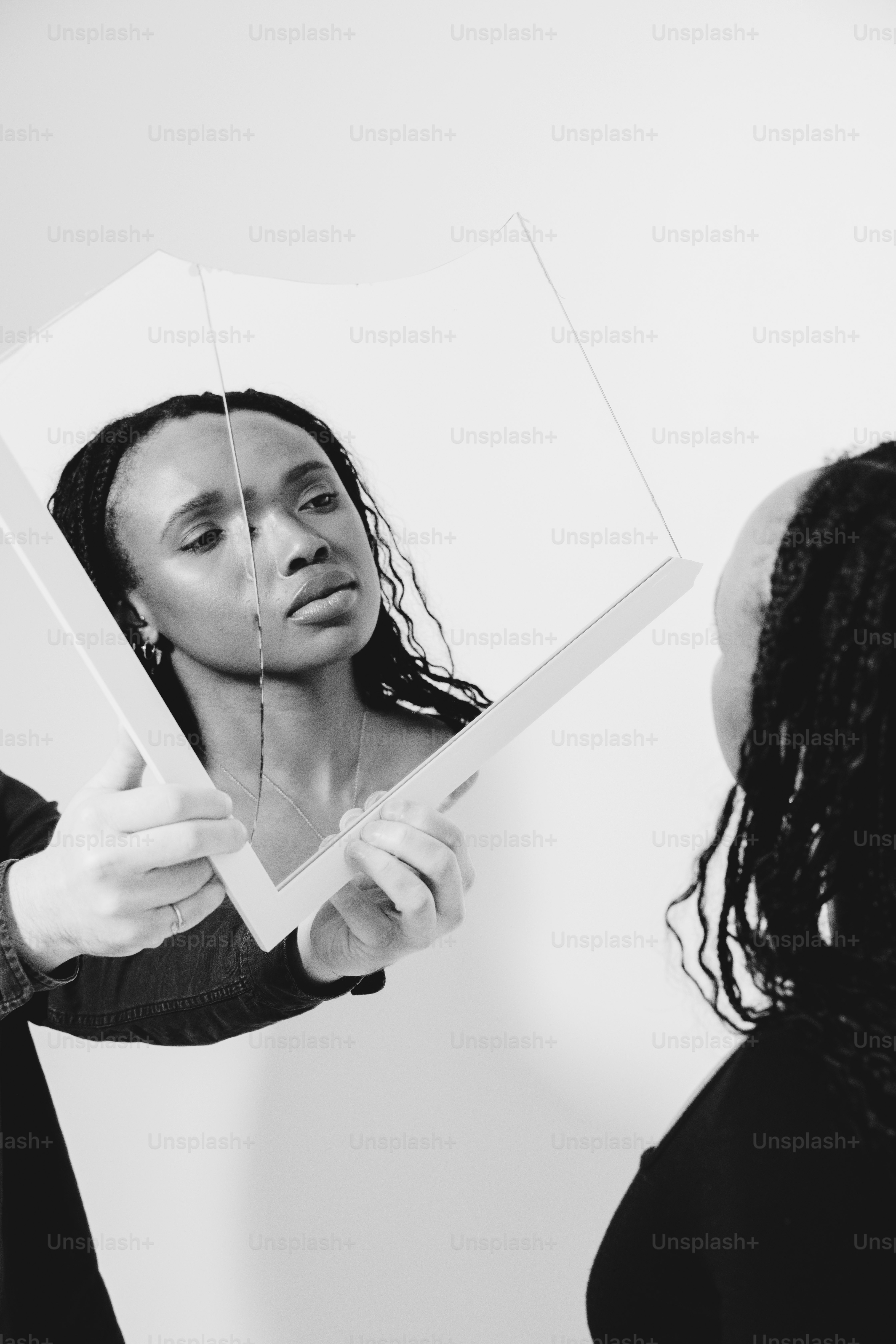 A woman holding a colorful cube in front of her face photo ...