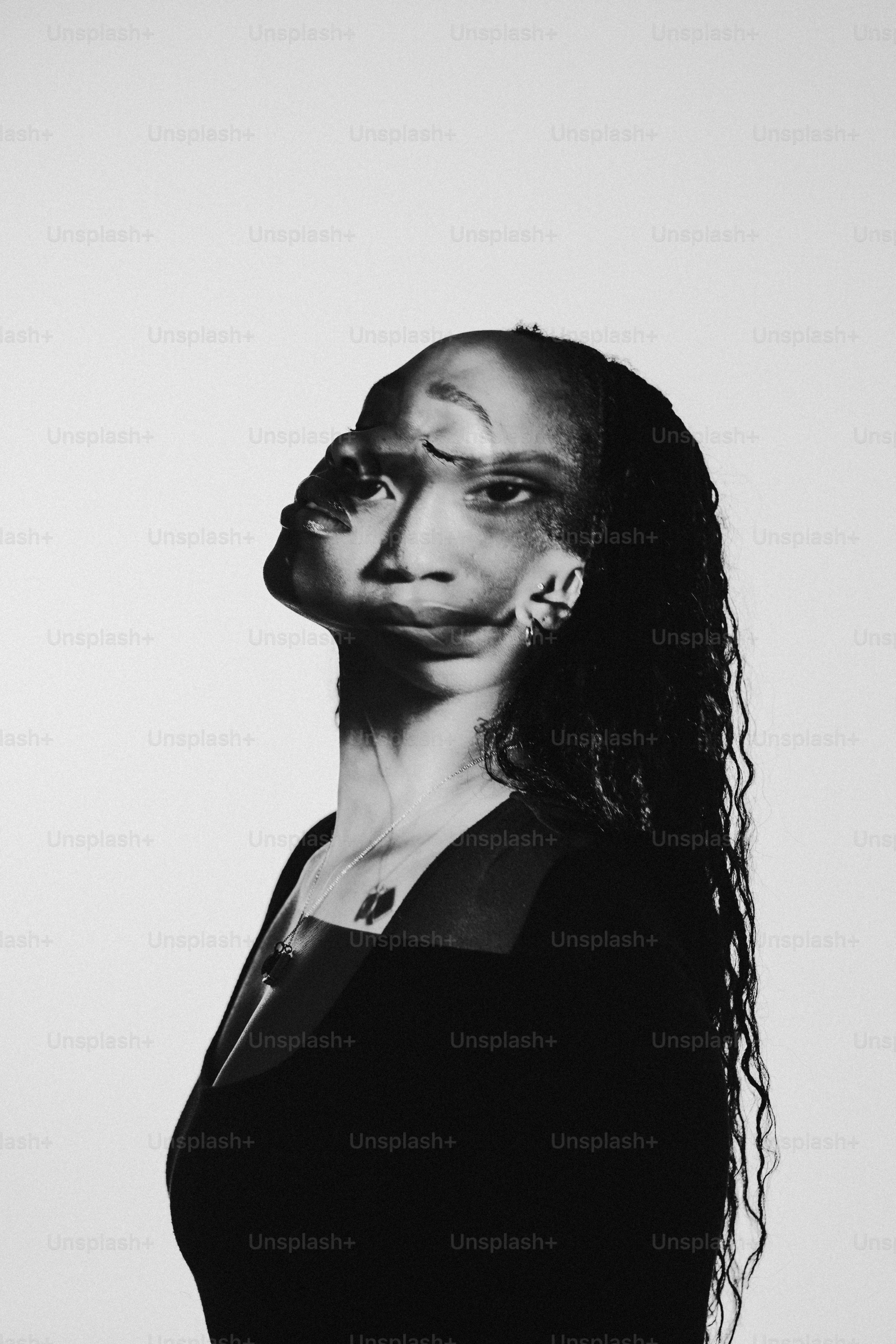 A woman holding a colorful cube in front of her face photo – Headshot ...