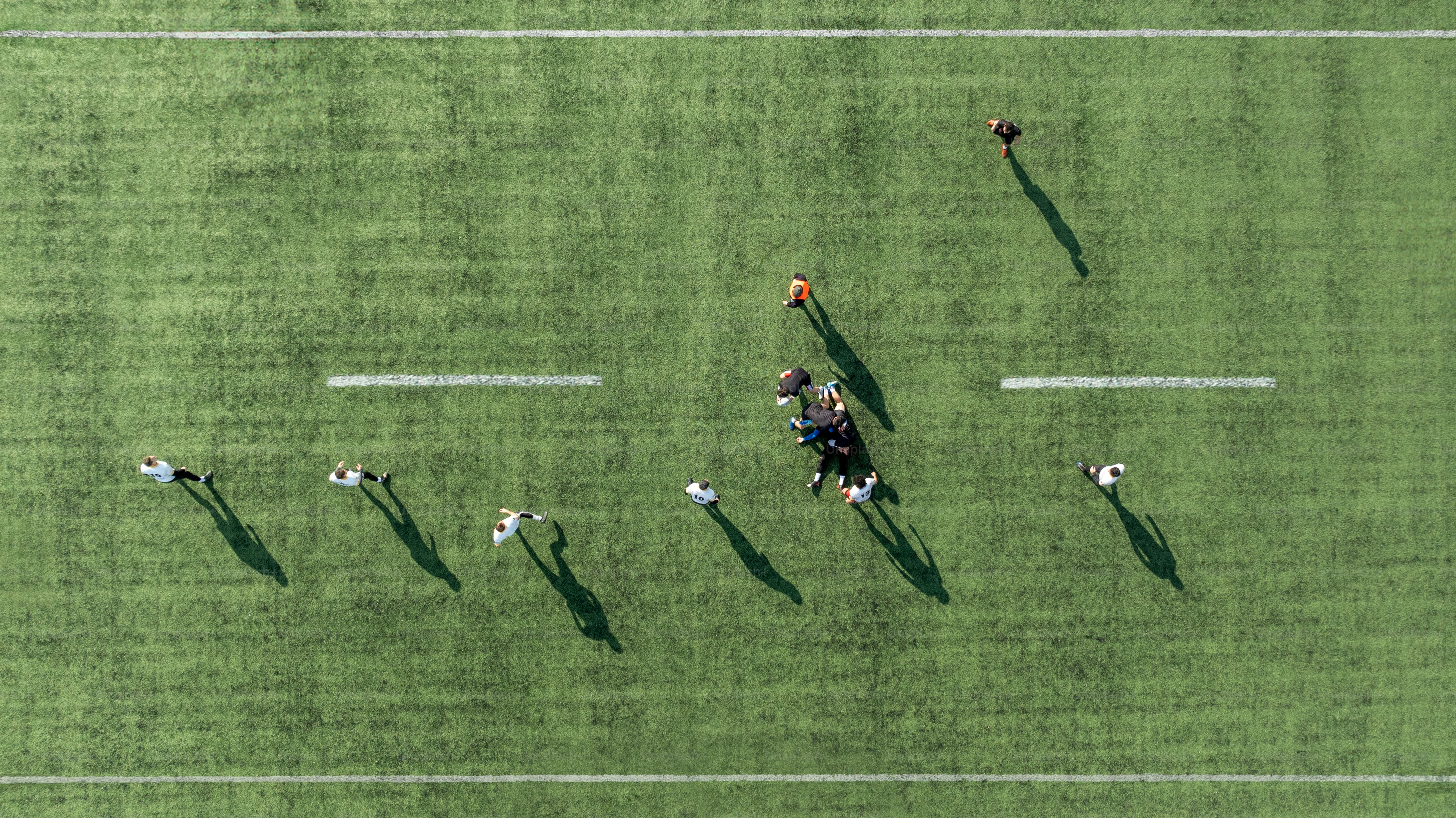 A group of people standing on top of a lush green field photo – Rugby ...