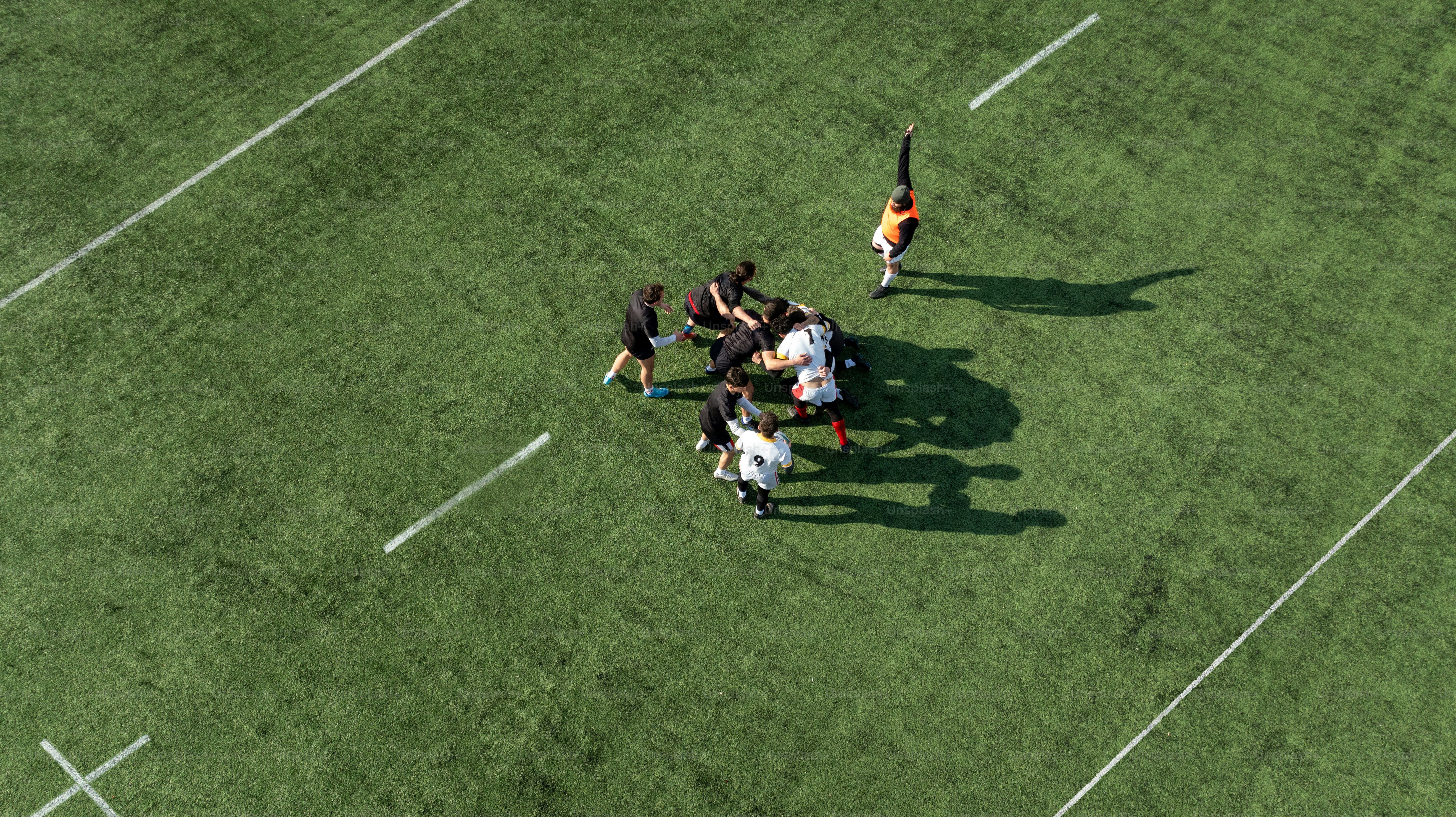 A group of people standing on top of a lush green field photo – Rugby ...