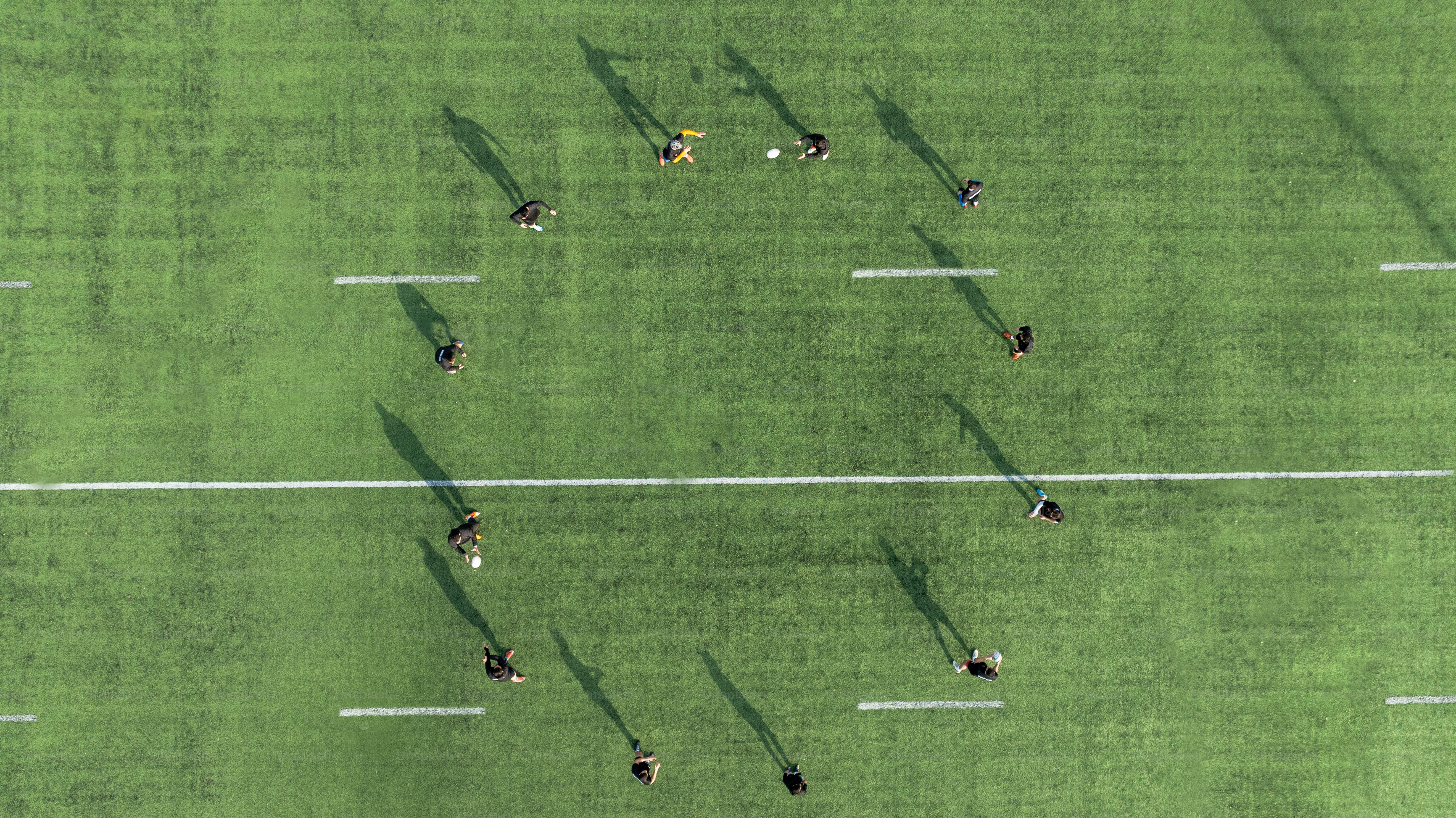 A group of people playing a game of frisbee photo – Rugby Image on Unsplash