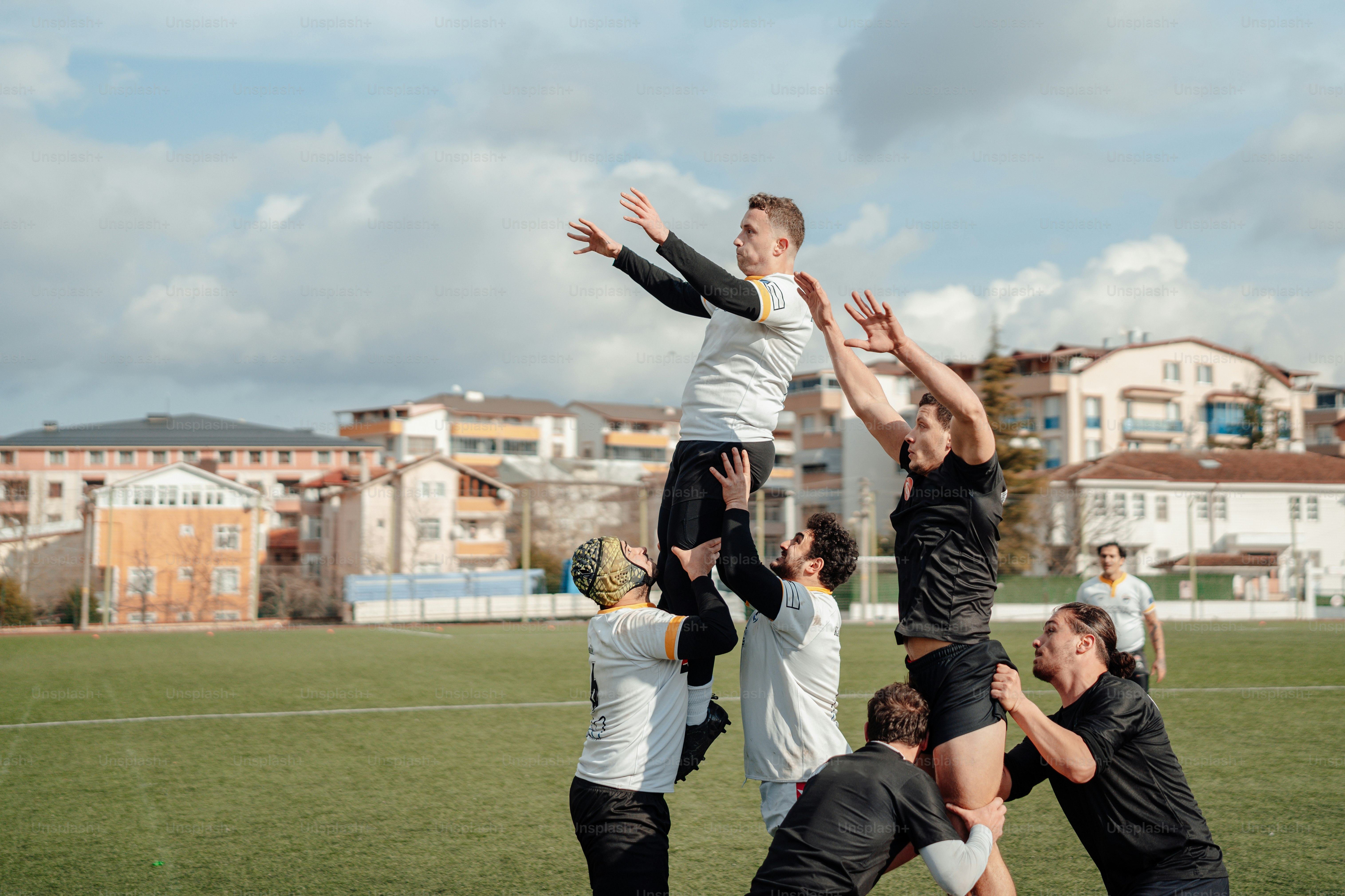 A group of young men playing a game of frisbee photo – Rugby Image on ...