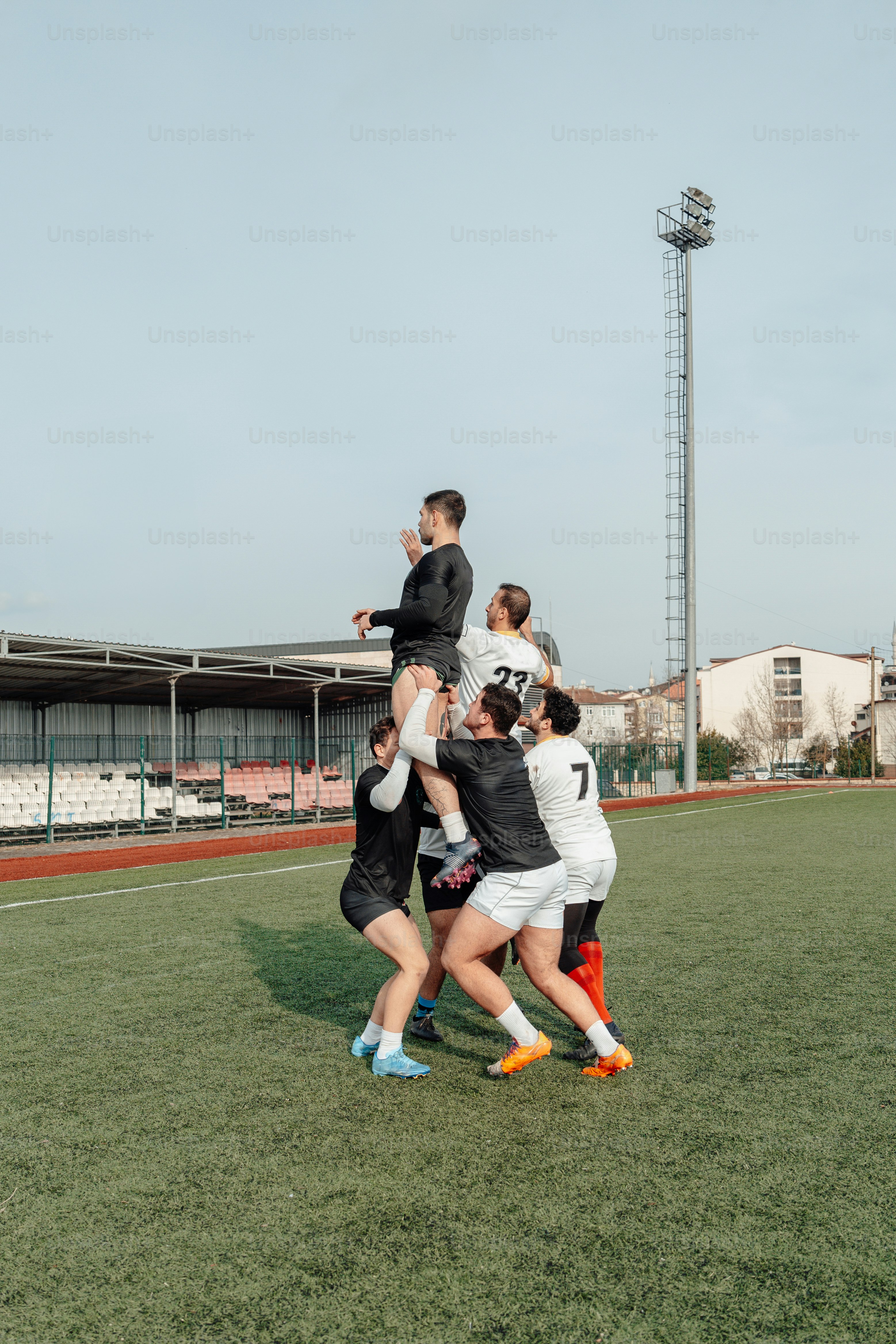 A group of young men playing a game of frisbee photo – Rugby Image on ...
