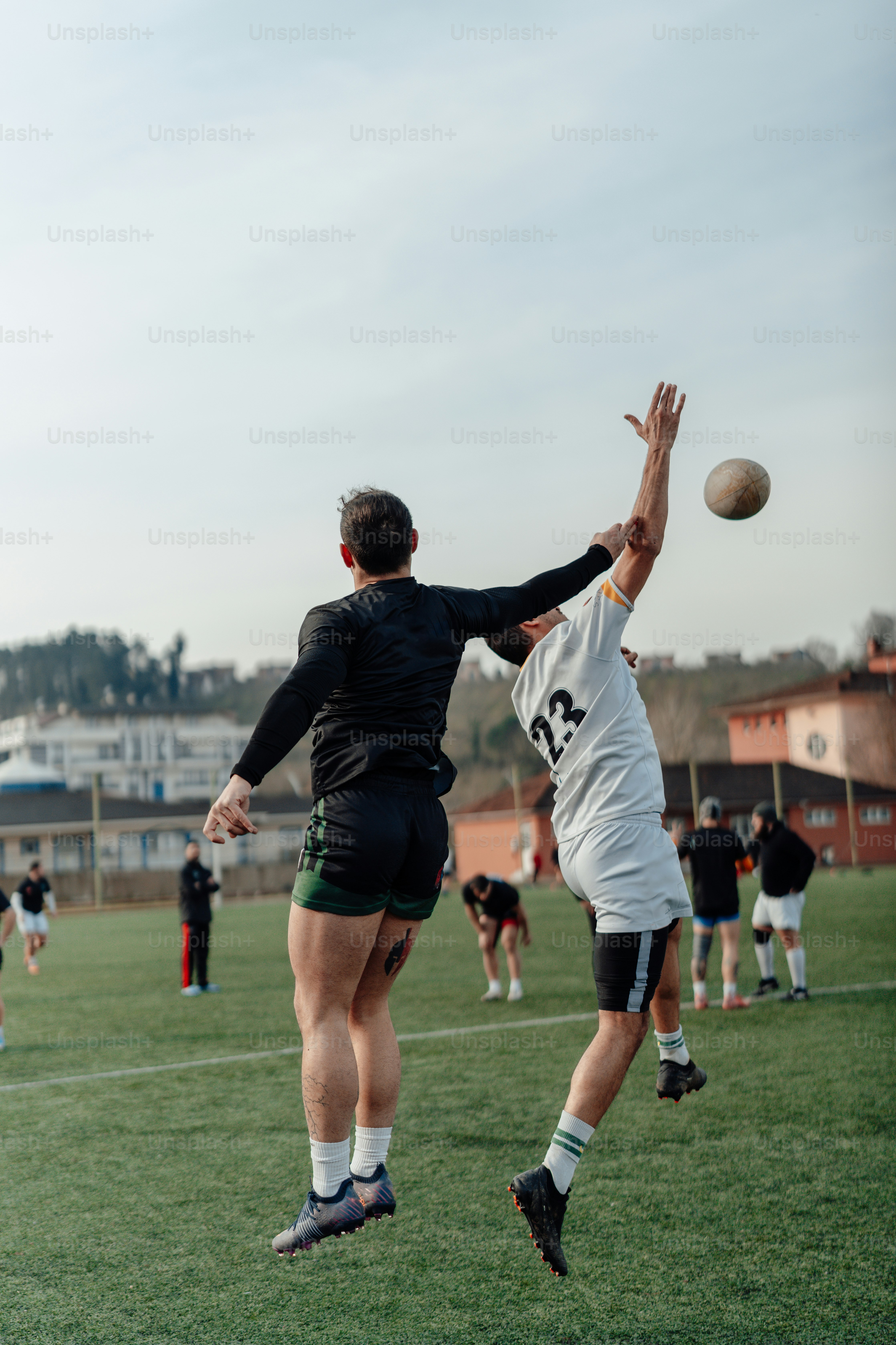 A couple of men playing a game of frisbee photo – Rugby Image on Unsplash
