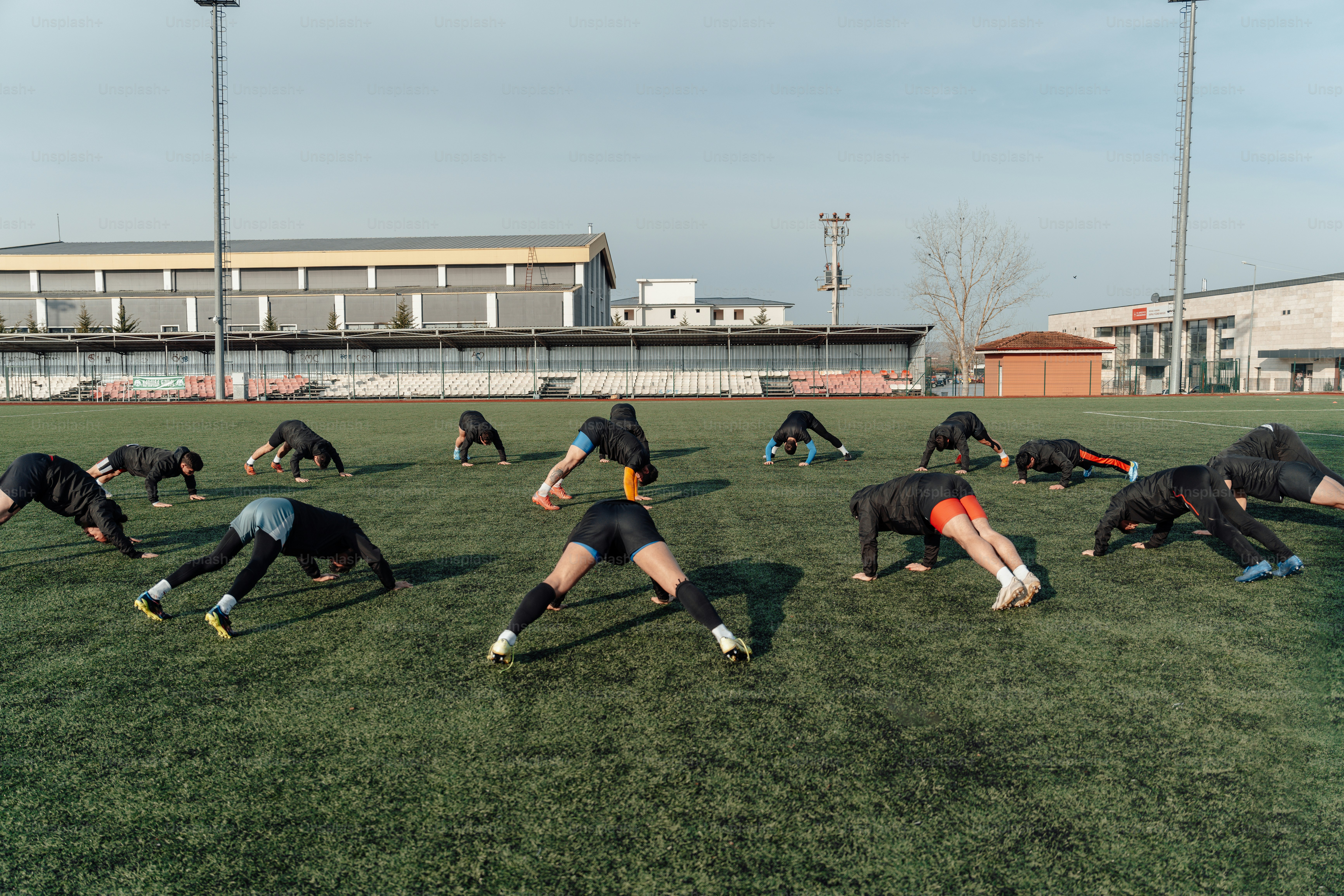 A group of people doing push ups on a field photo – Rugby Image on Unsplash