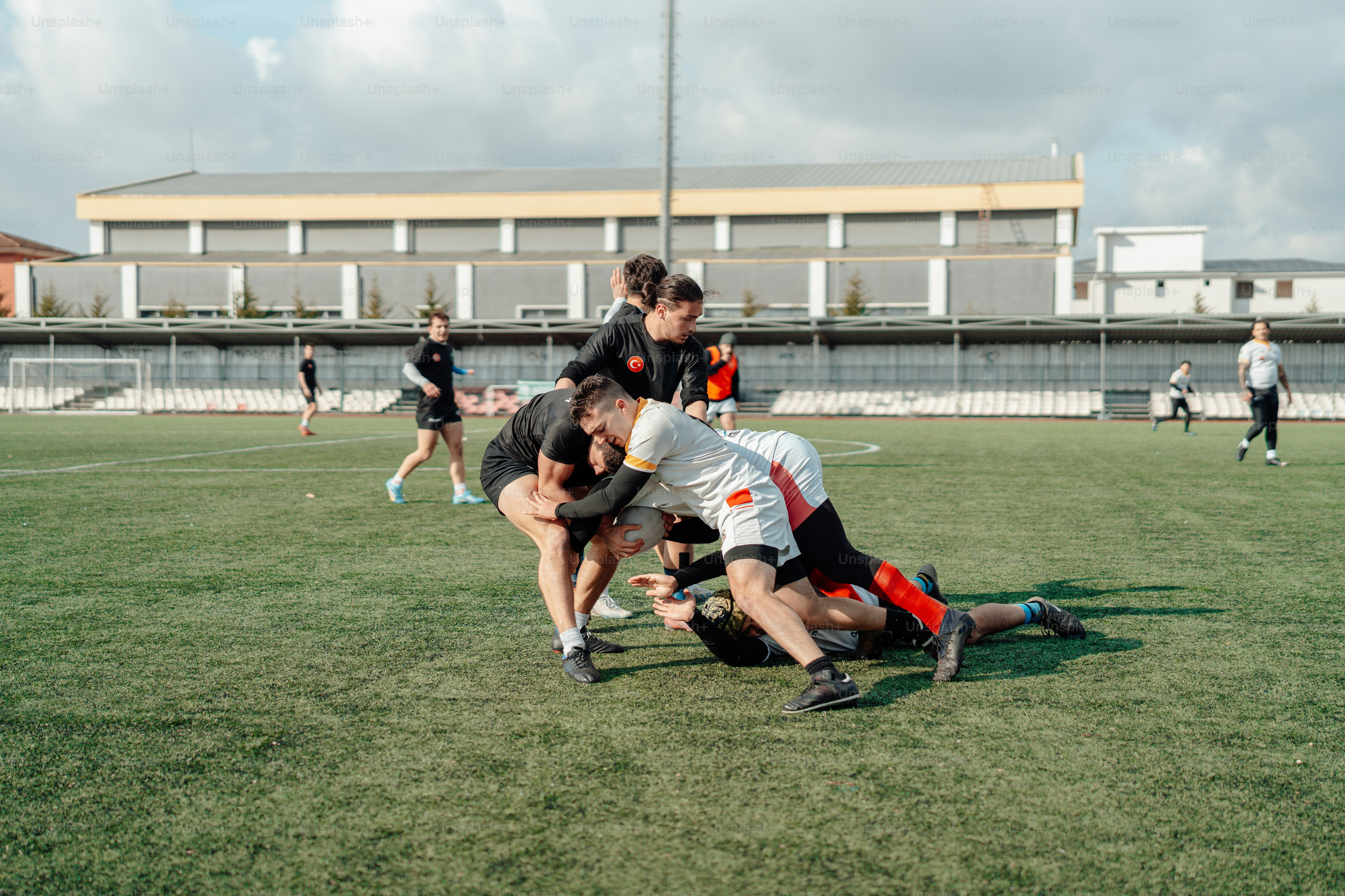 A group of young men playing a game of frisbee photo – Rugby Image on ...