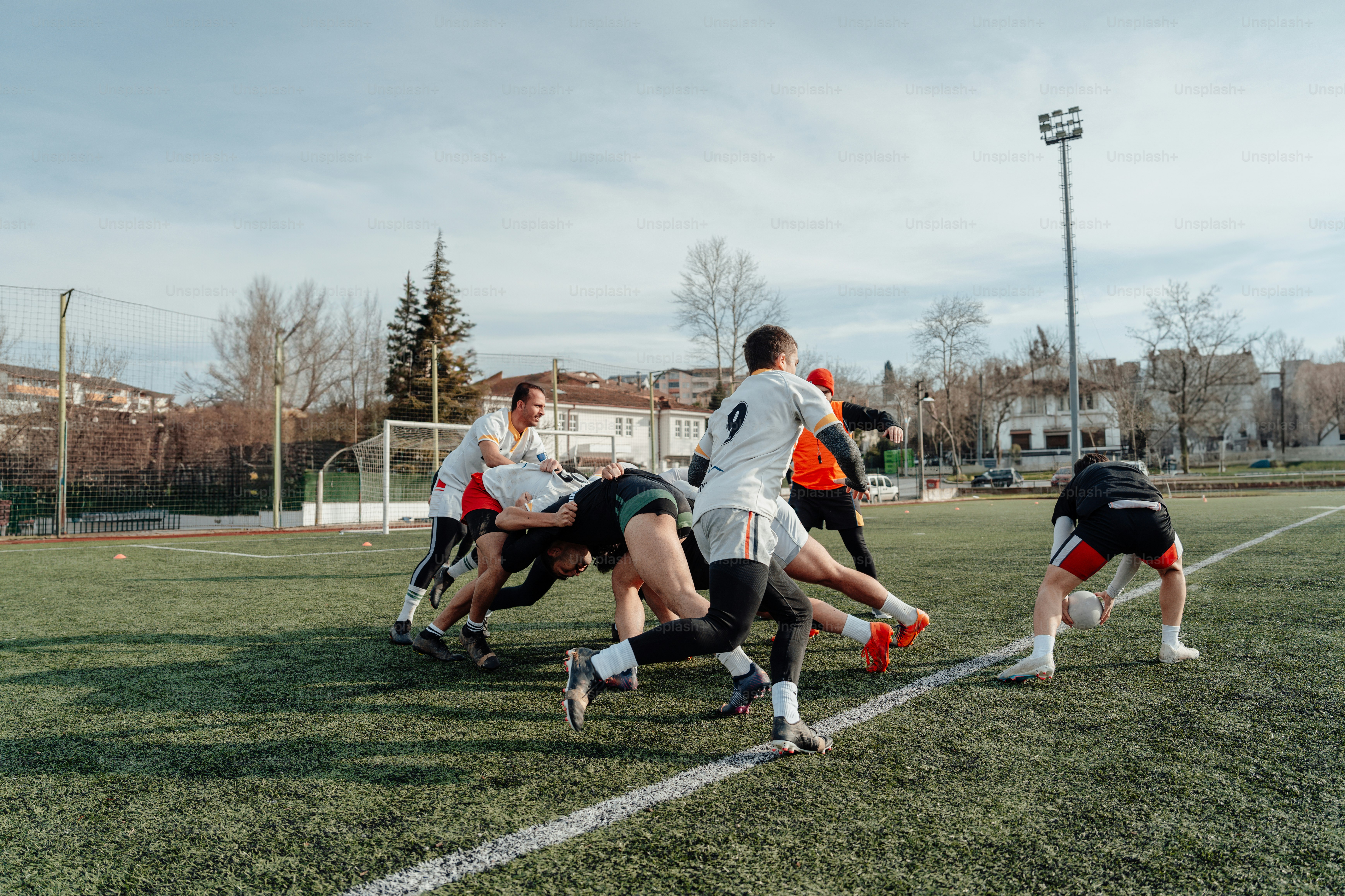A group of young men playing a game of frisbee photo – Rugby Image on ...
