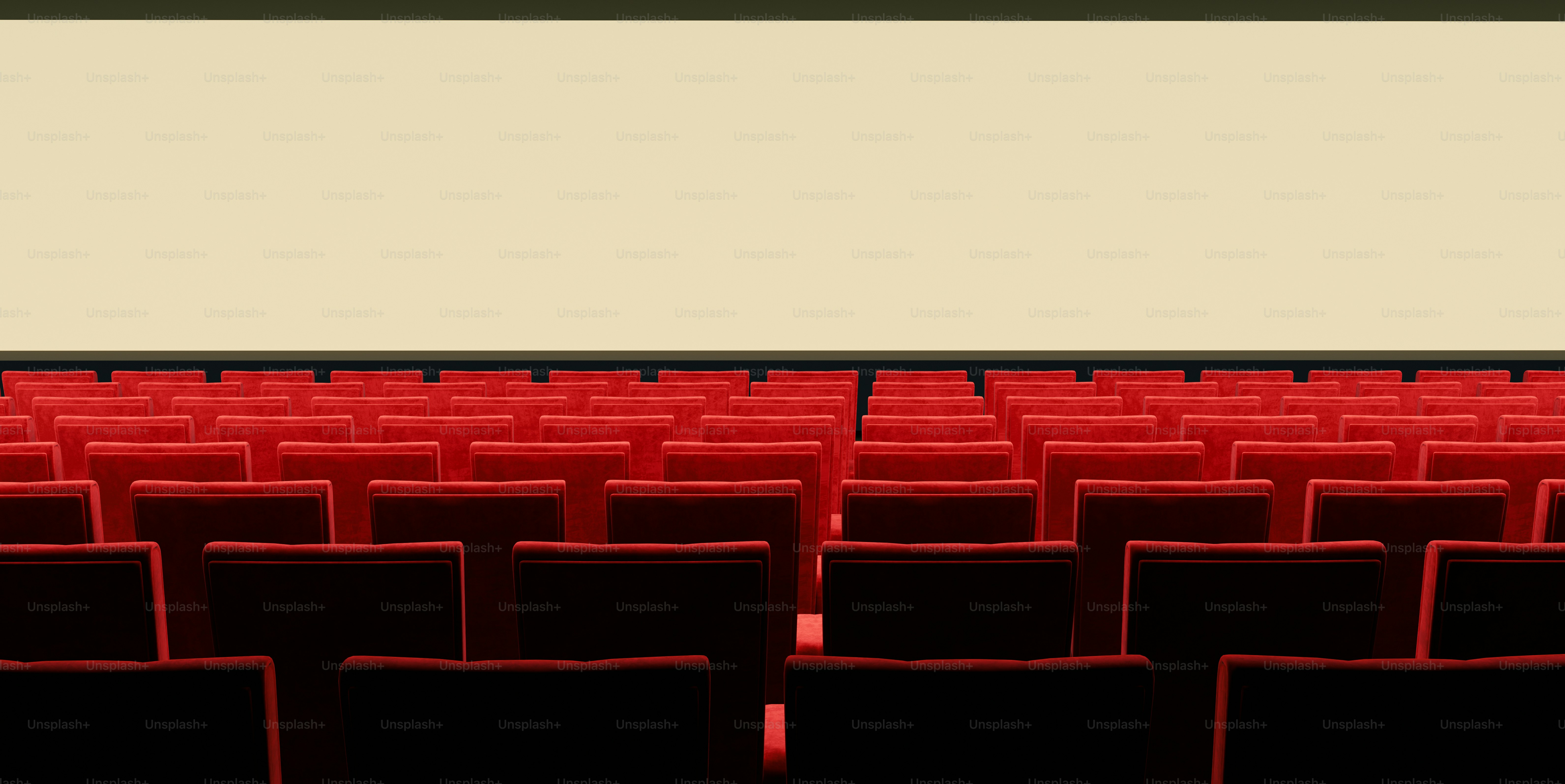 A row of red chairs in front of a white screen photo – Digital image ...