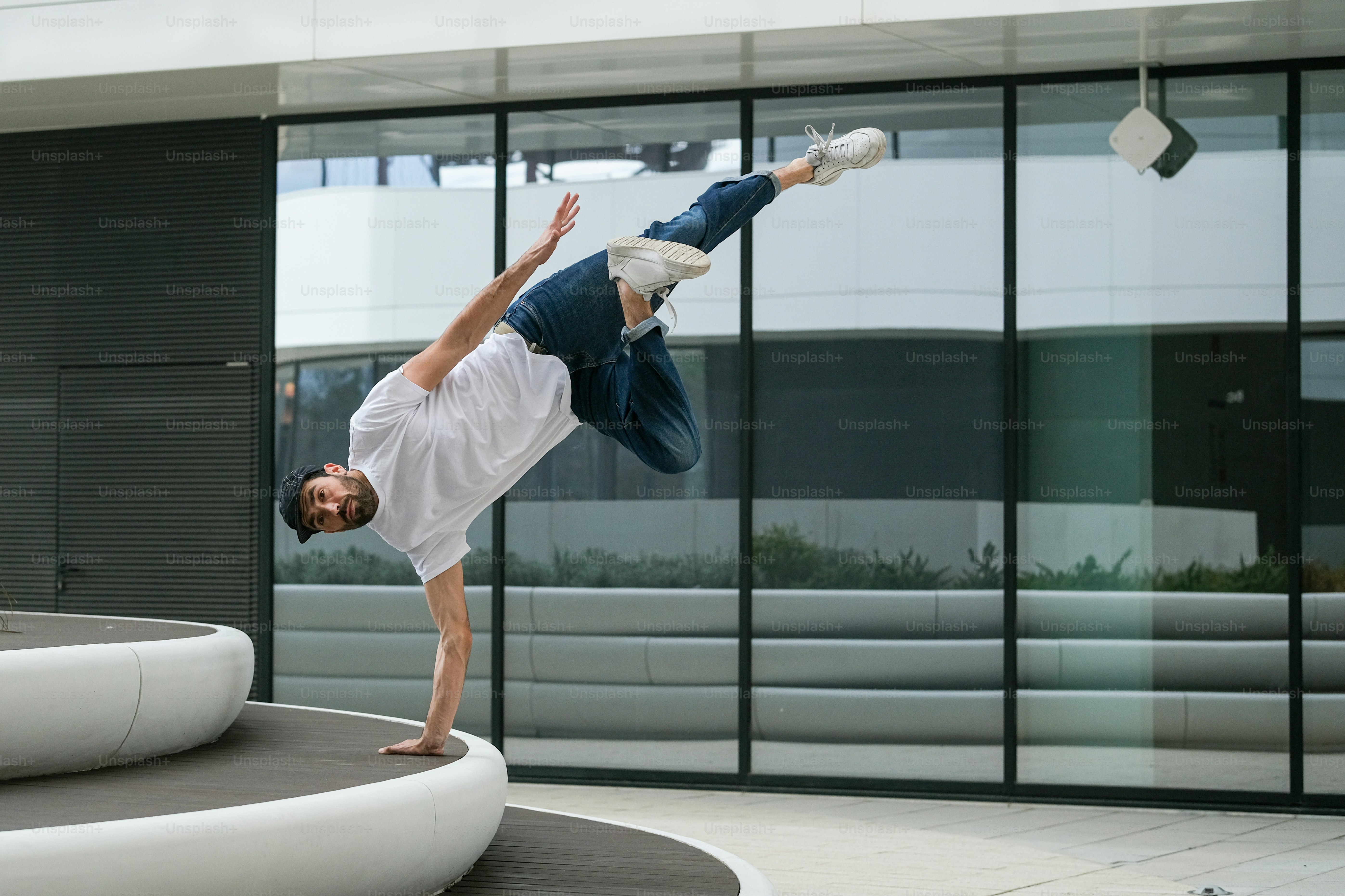 A man doing a handstand in front of a building photo – City Image on ...