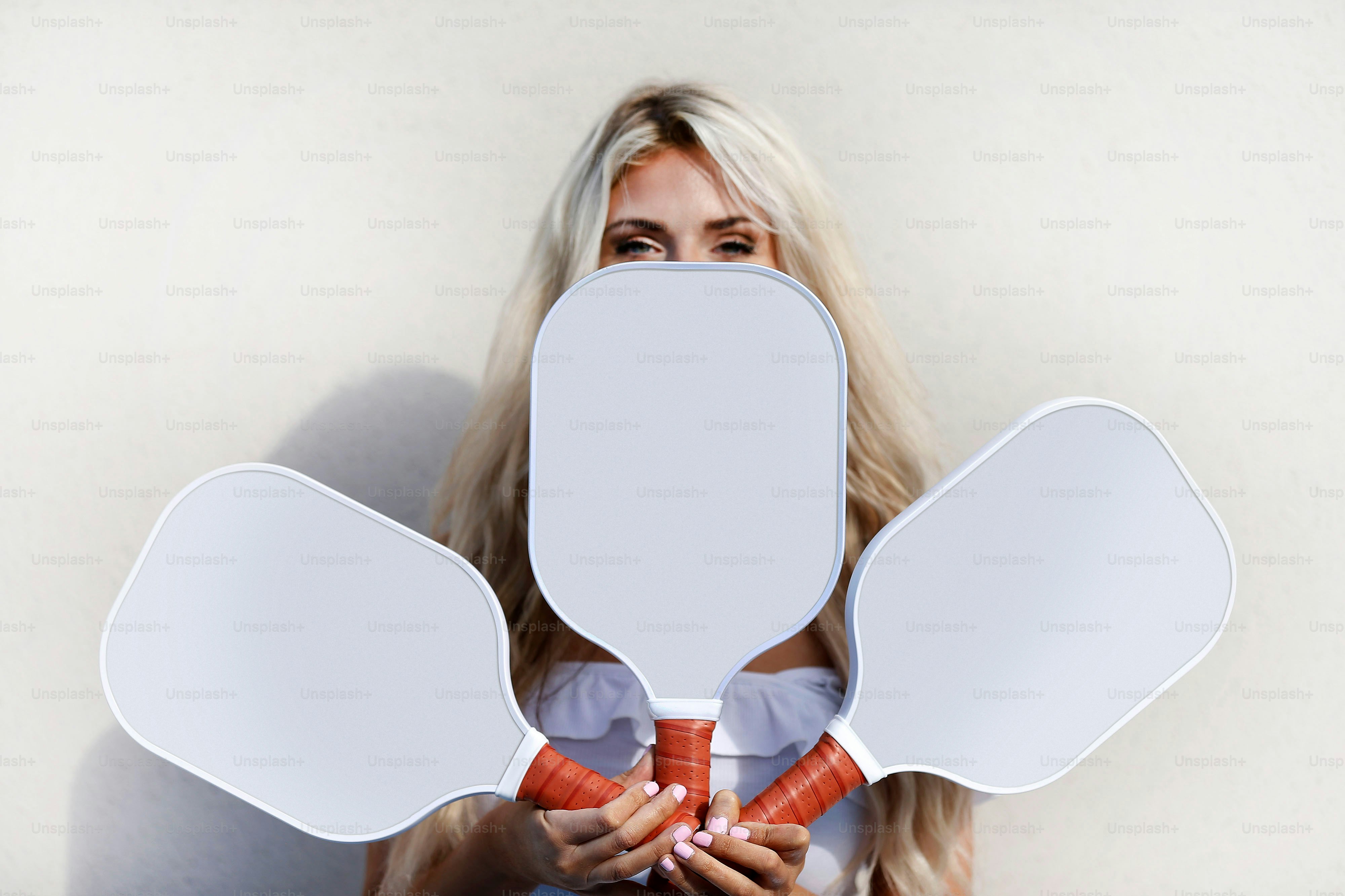 A woman holding up two large mirrors to her face photo – Pickleball ...