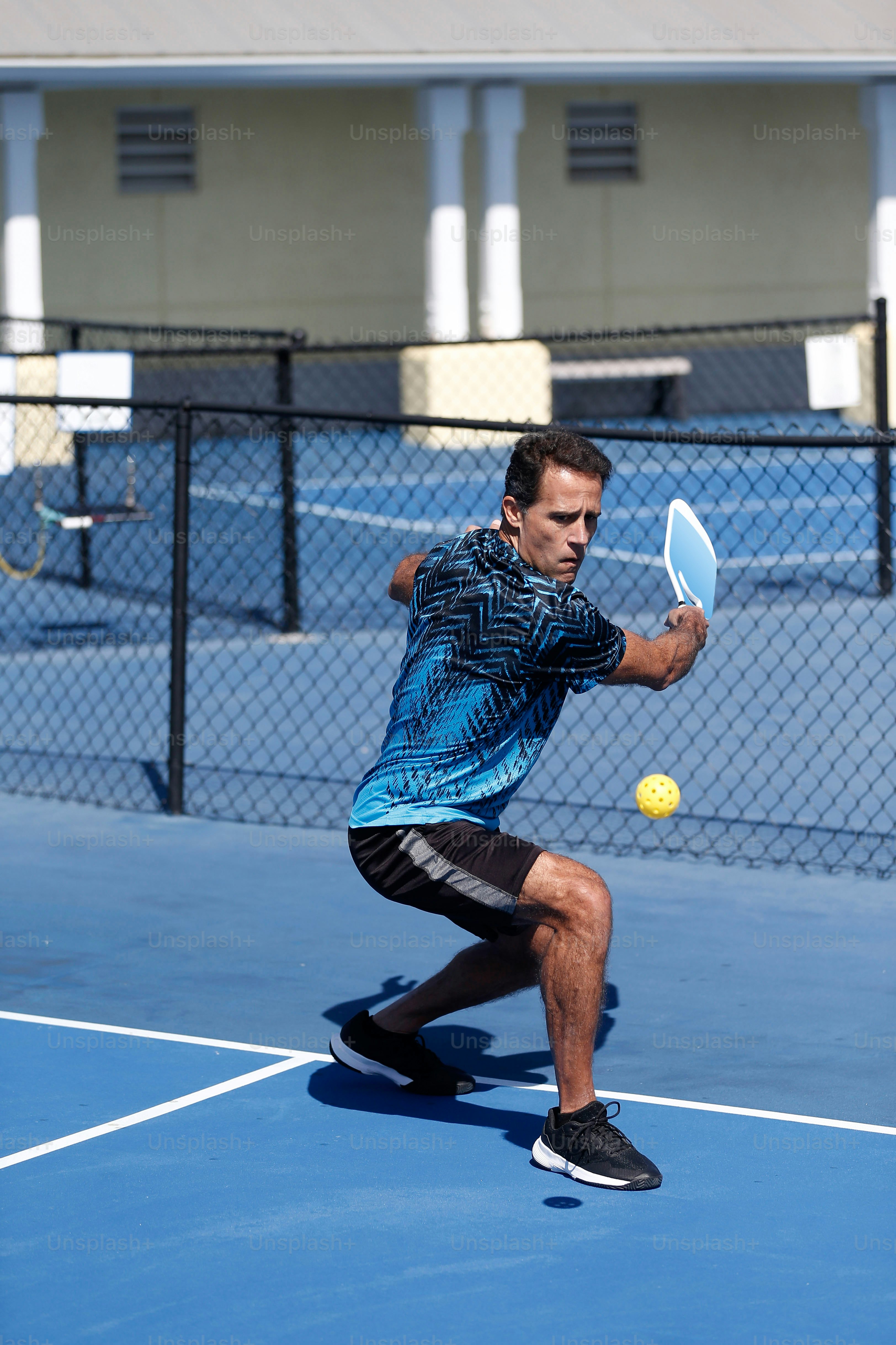 A woman holding a tennis racquet on a tennis court photo – Racket Image ...