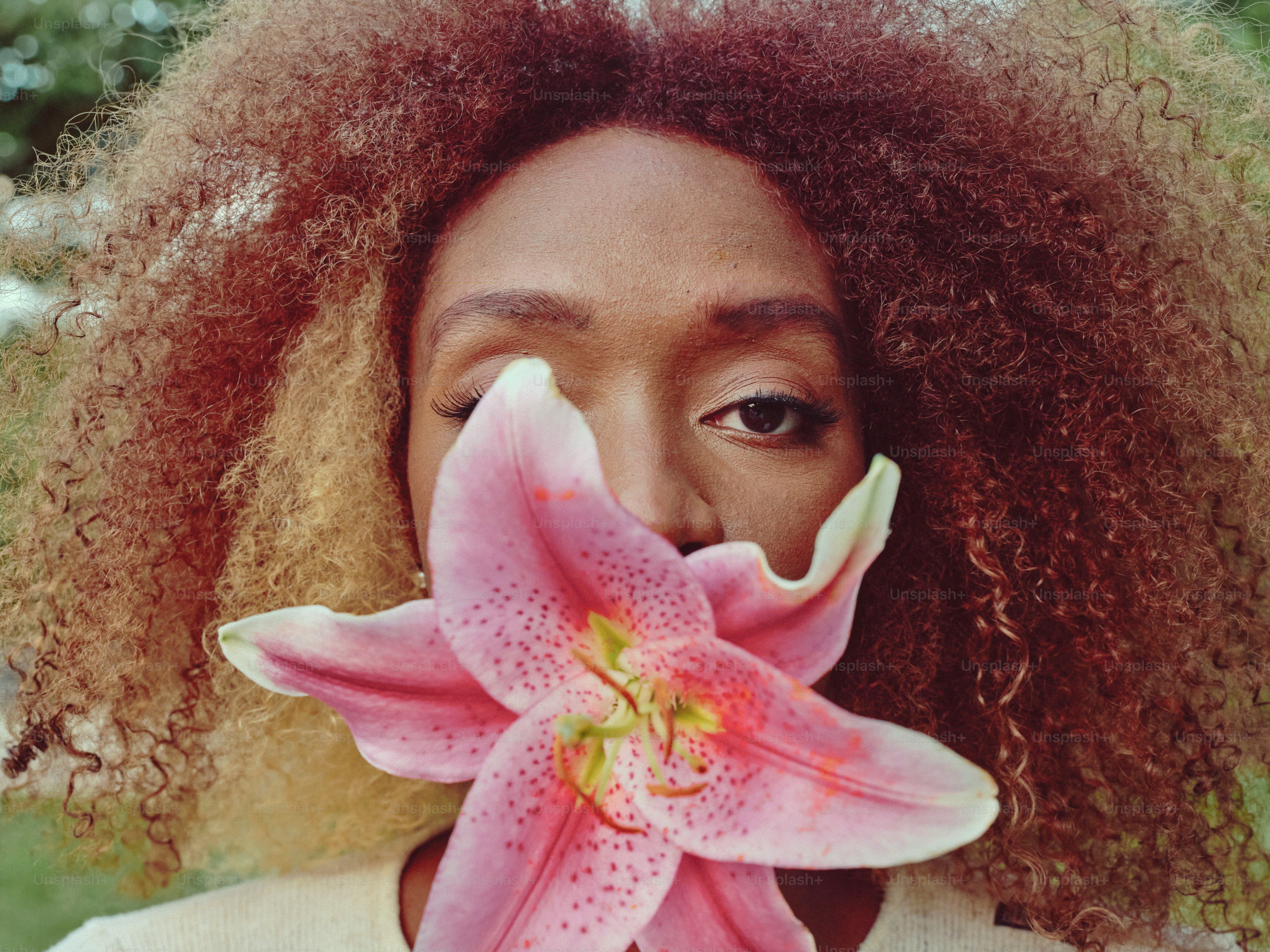 A close up of a person with a flower in their mouth photo – Flowers ...