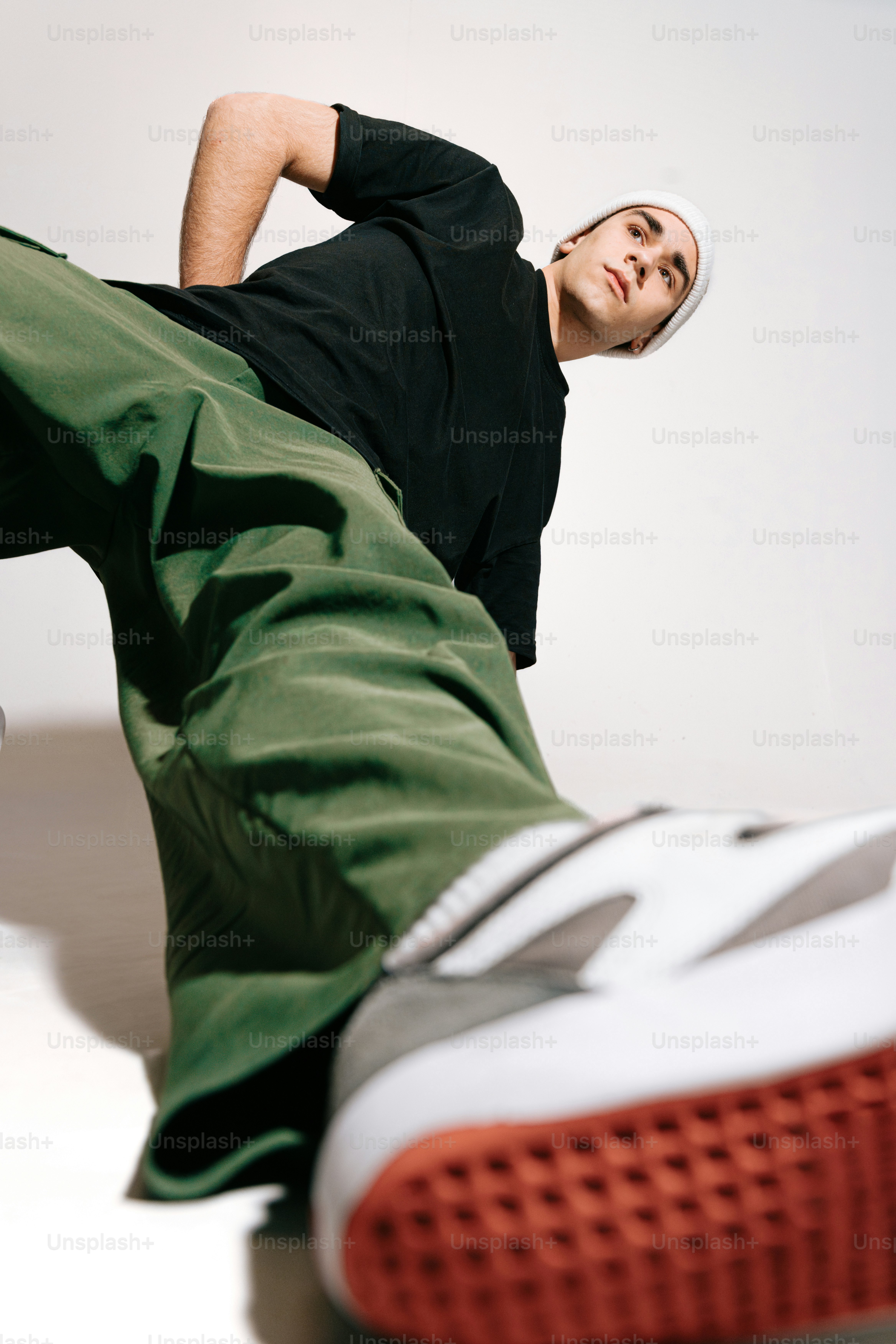 A man laying on the ground with his foot on the ground photo ...