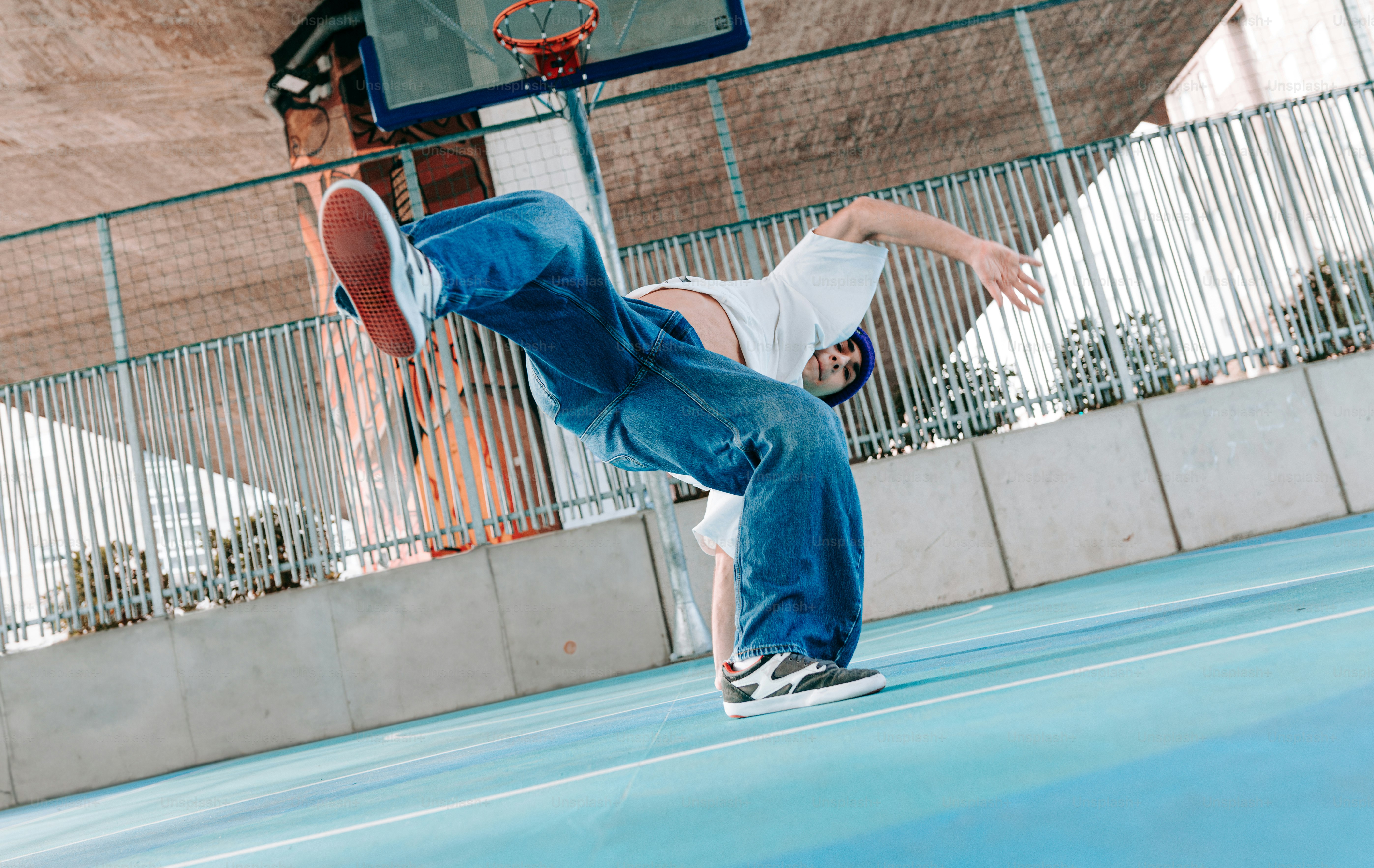 A man is doing a trick on a basketball court photo – Urban Image on ...