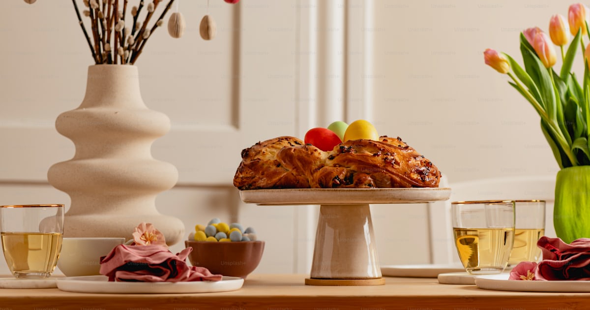 A Table Topped With A Cake Next To A Vase Filled With Flowers Photo