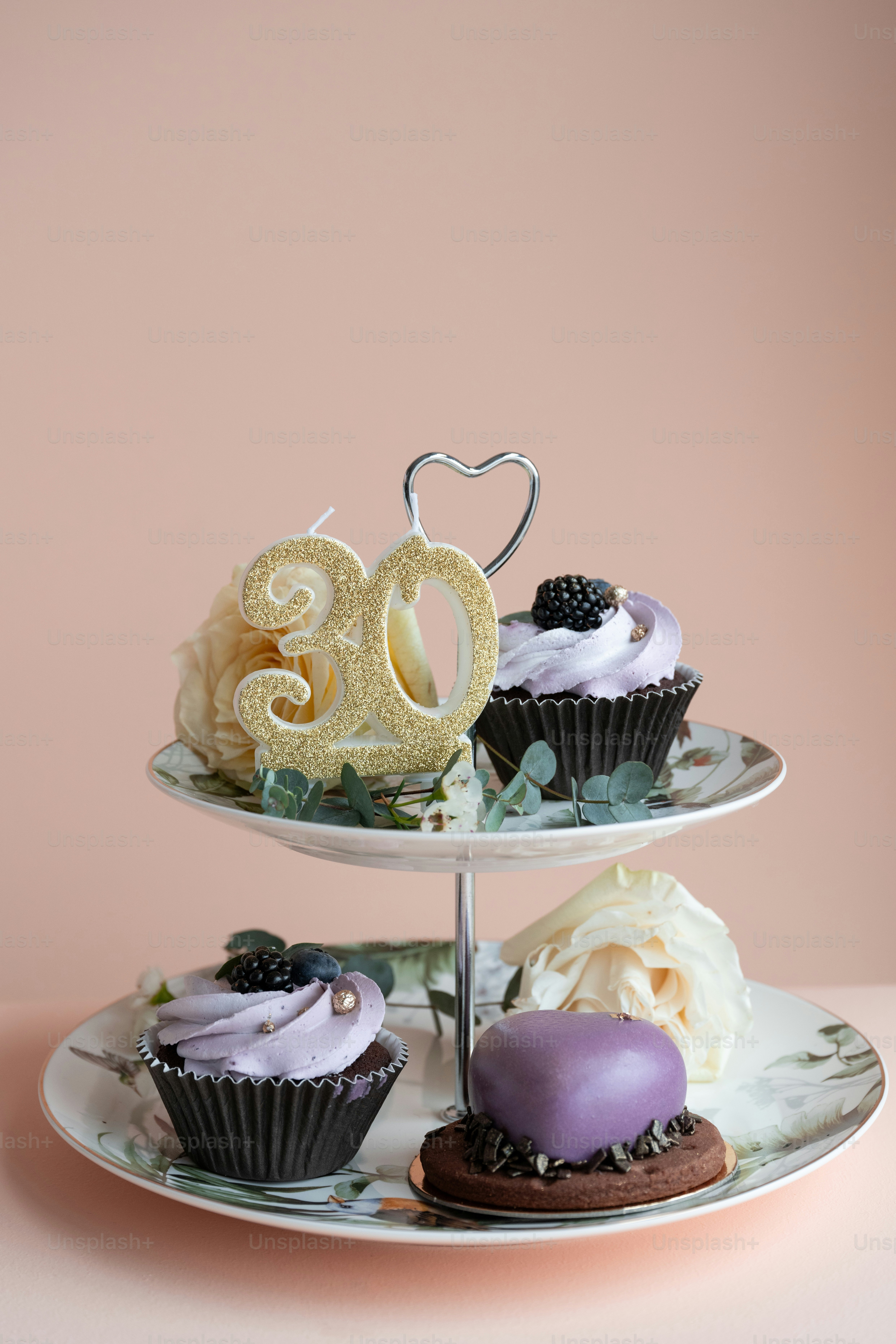 A three tiered plate with cupcakes and a cake photo – Cake Image on ...
