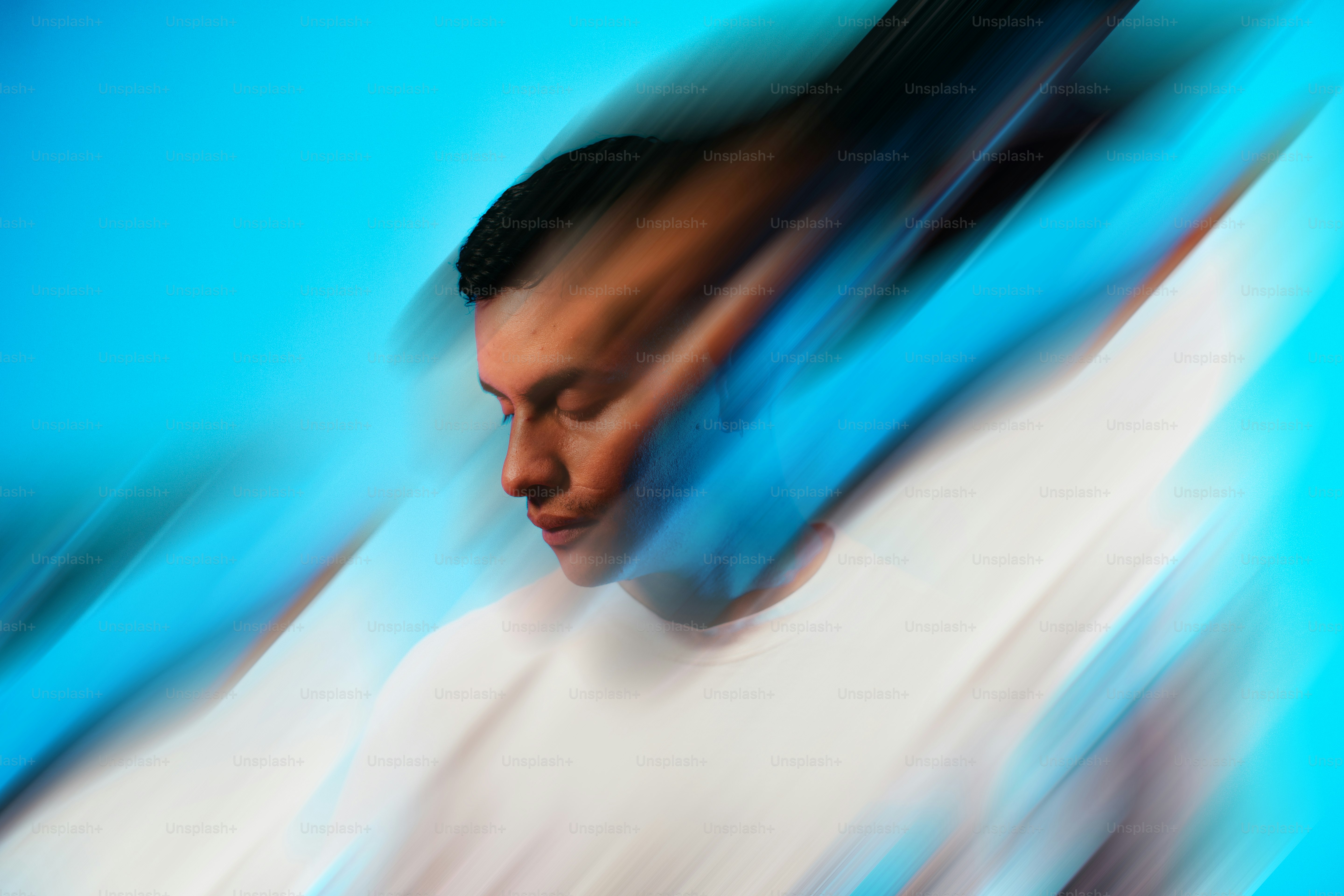 A blurry photo of a man in a white shirt photo – Portrait Image on Unsplash