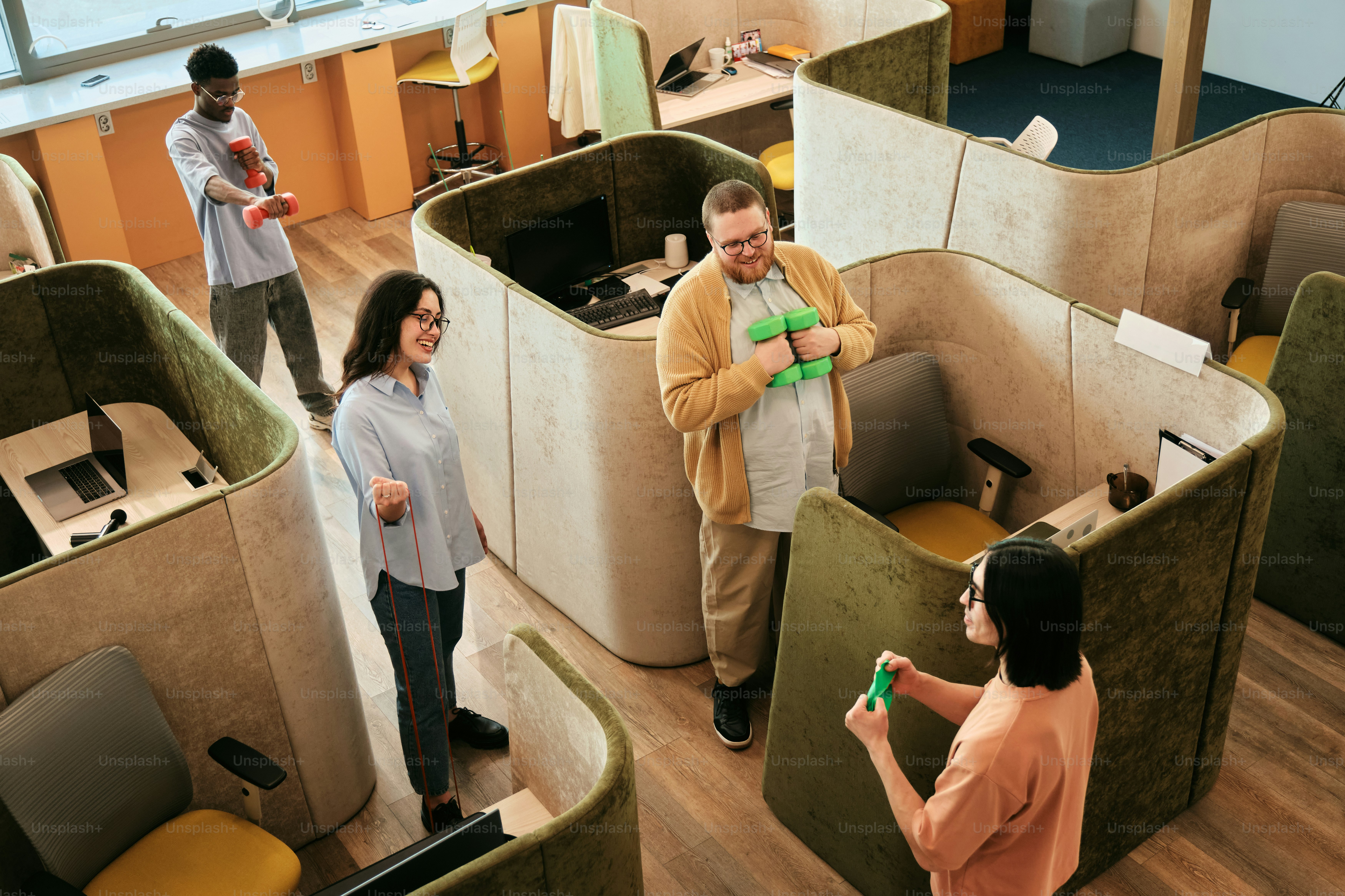 A group of people standing around a cubicle in an office photo – Image ...