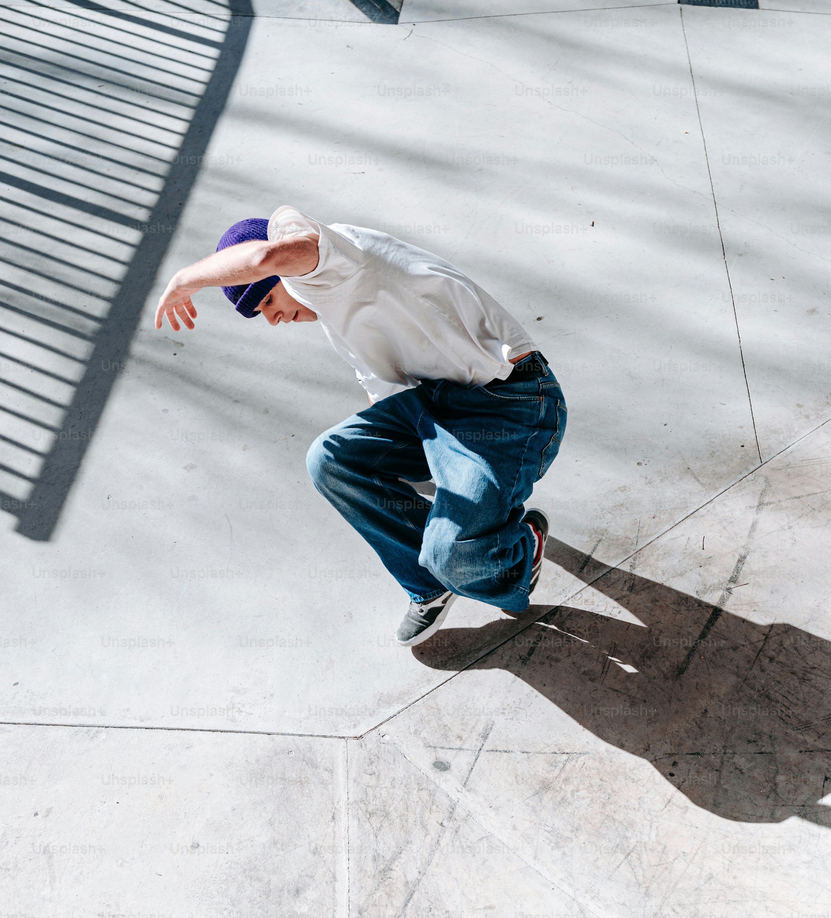 A young man riding a skateboard under a bridge photo – Breakdance Image ...