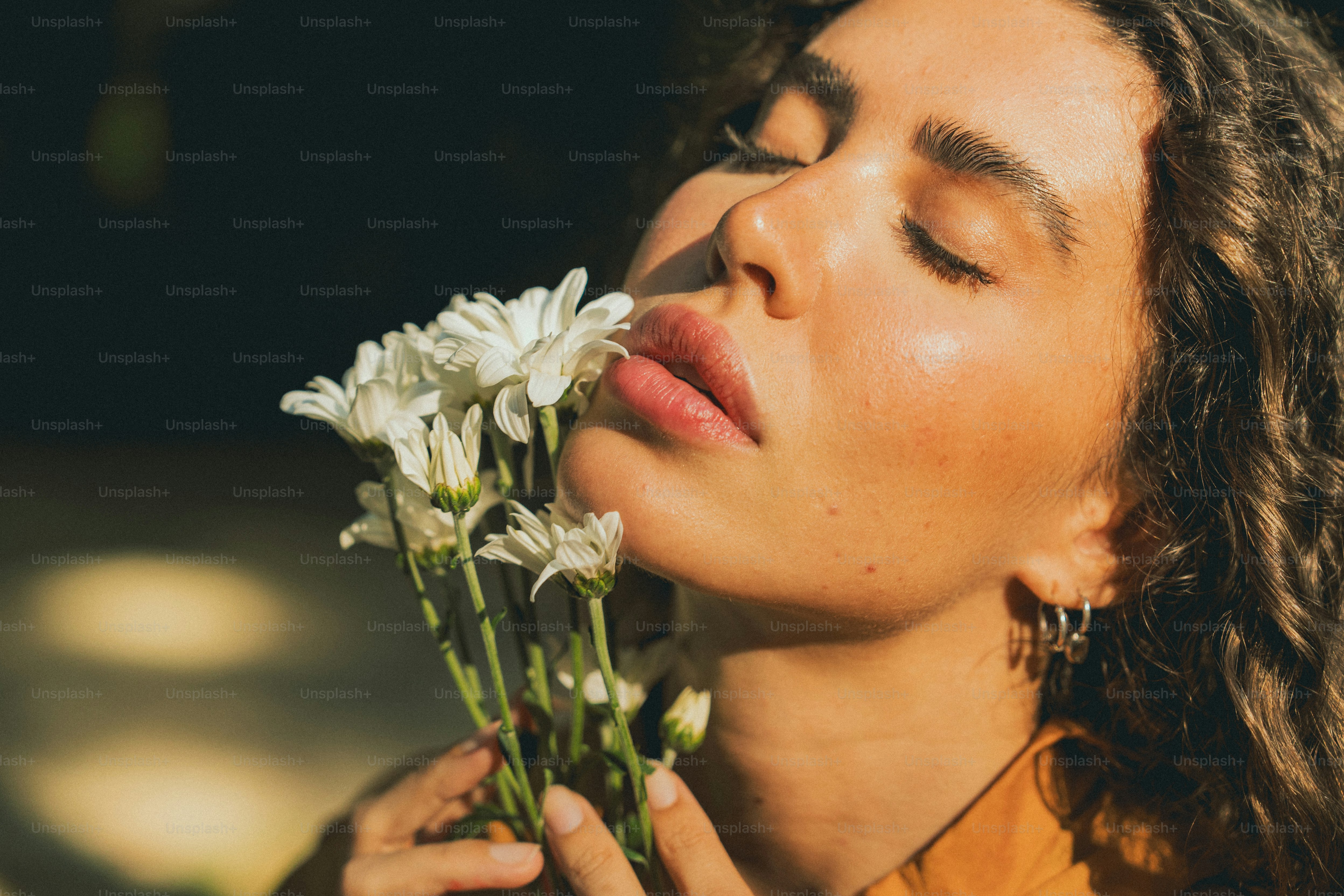 A woman smelling a bunch of white flowers photo – Flowers Image on Unsplash