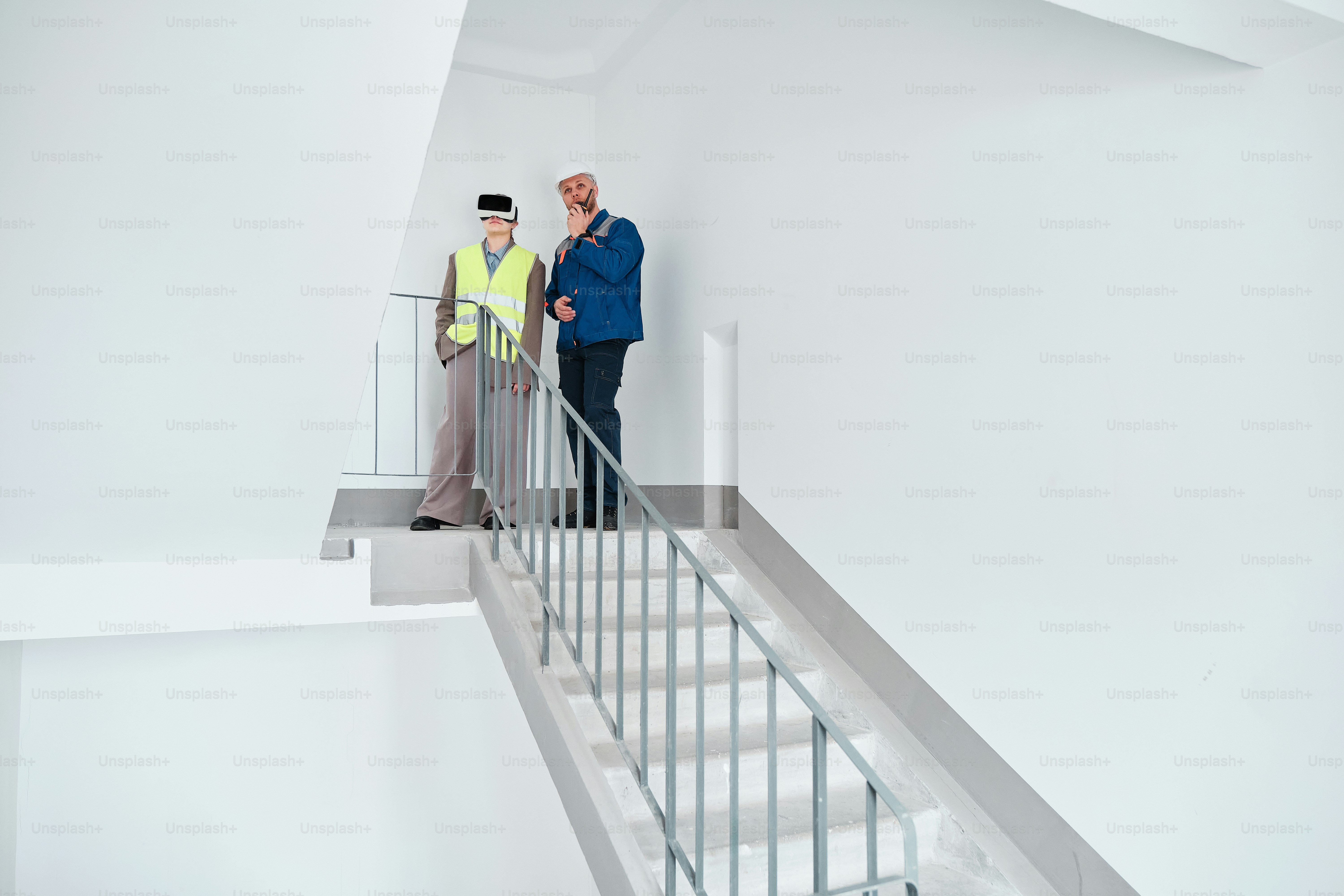 A couple of men standing on top of a stair case photo – Woman Image on ...