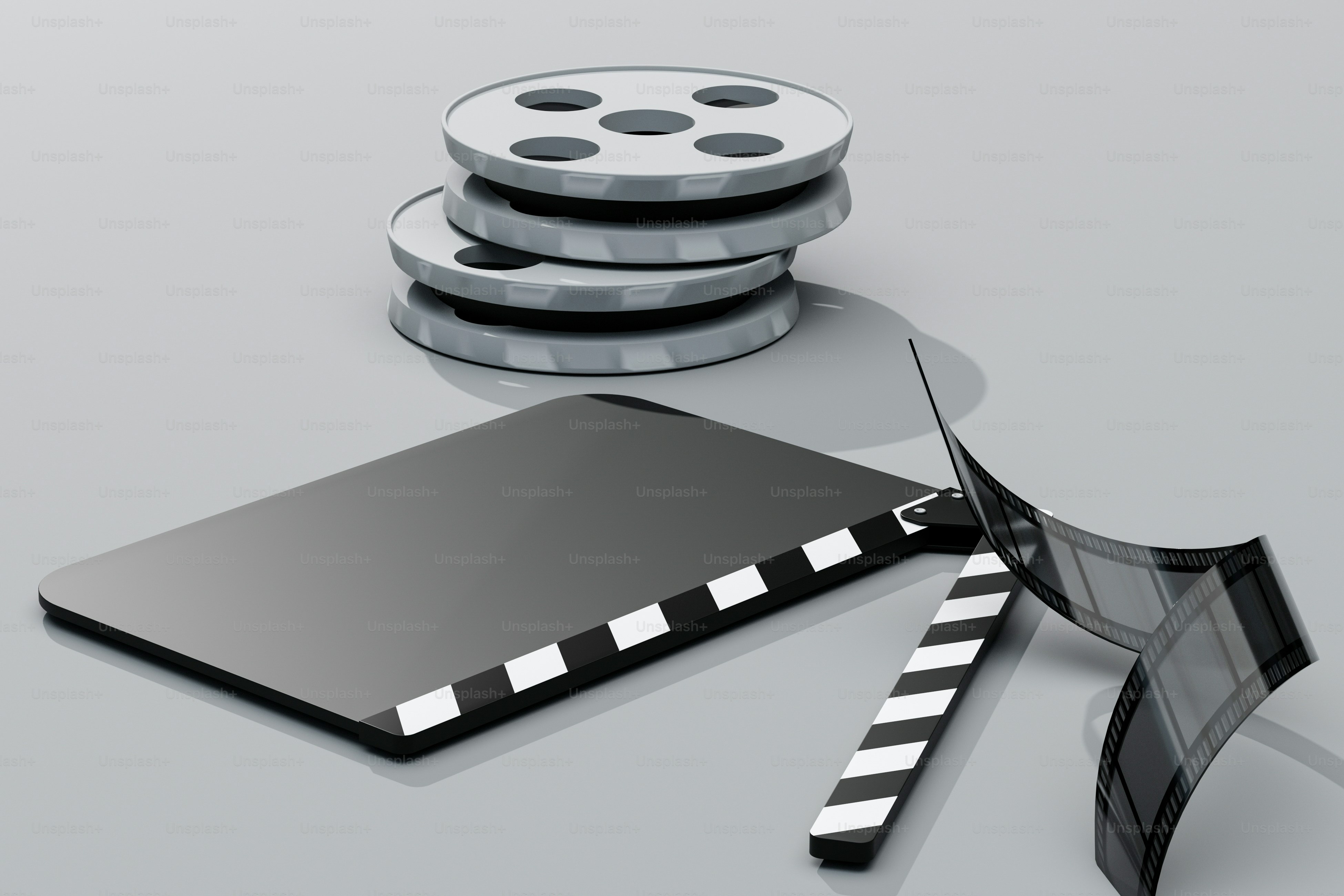 A film reel and a film strip on a table photo – Film frame Image on ...