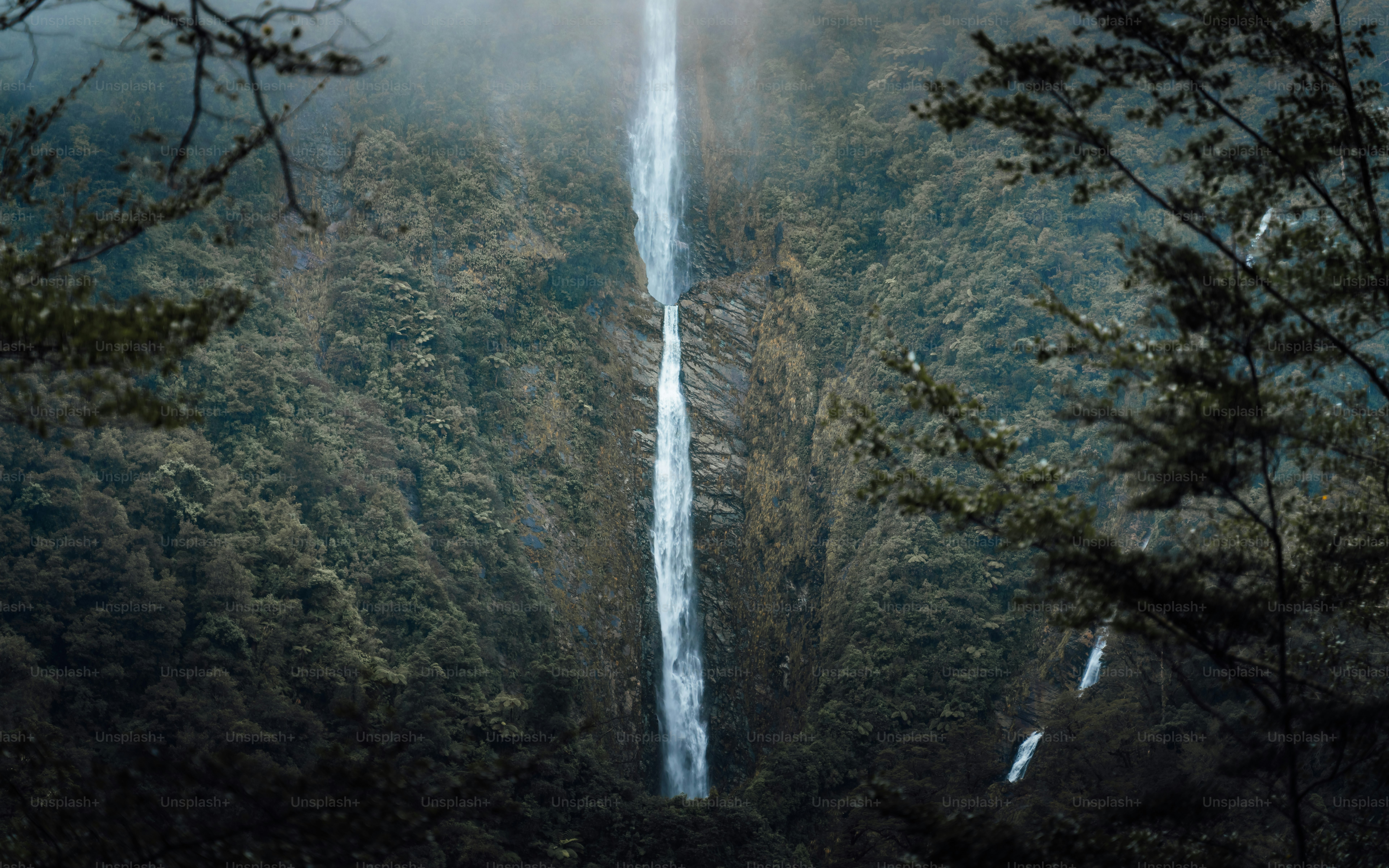 A waterfall in the middle of a body of water photo – Wallpaper 4k Image ...