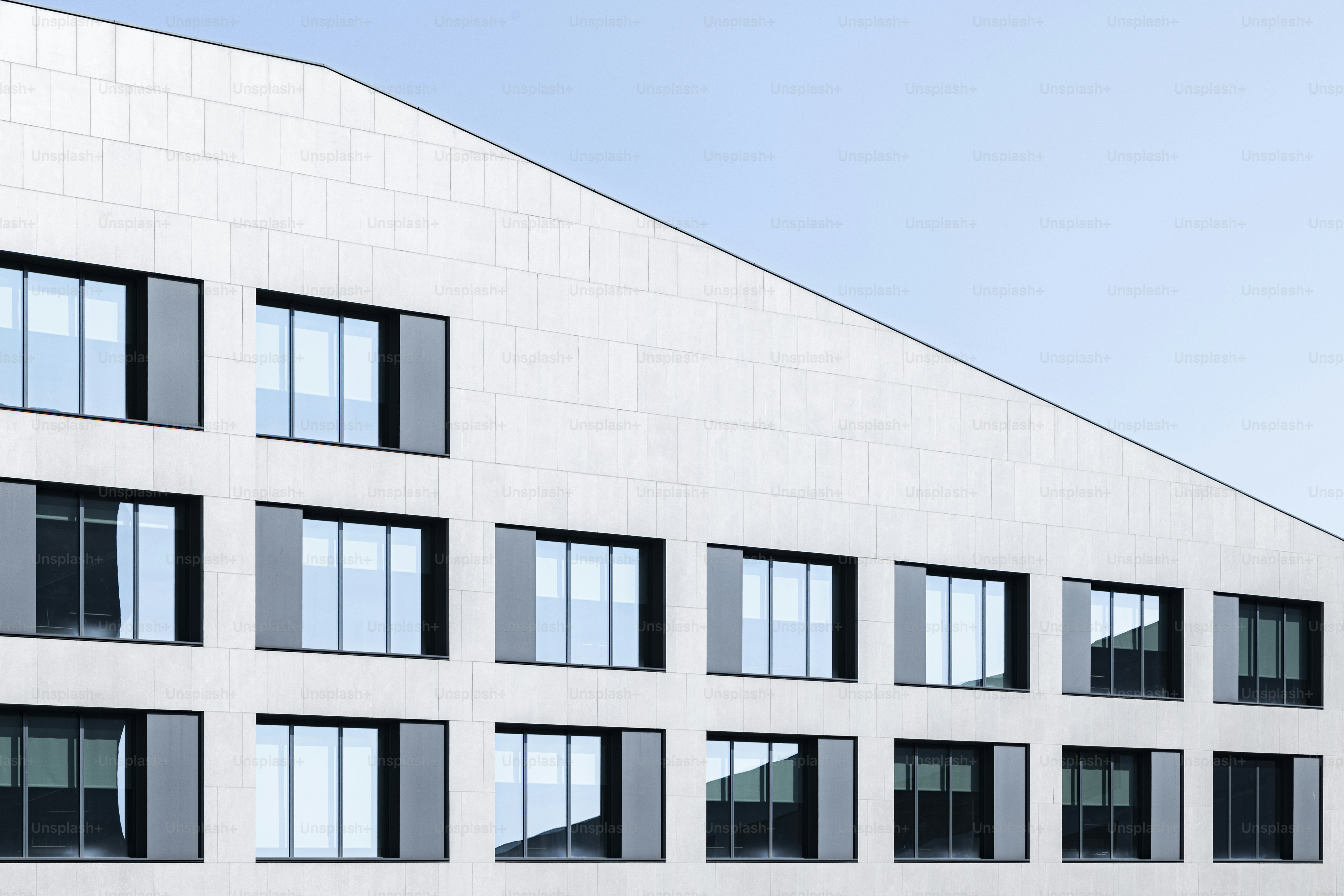A large white building with many windows on it photo – Abstract Image ...