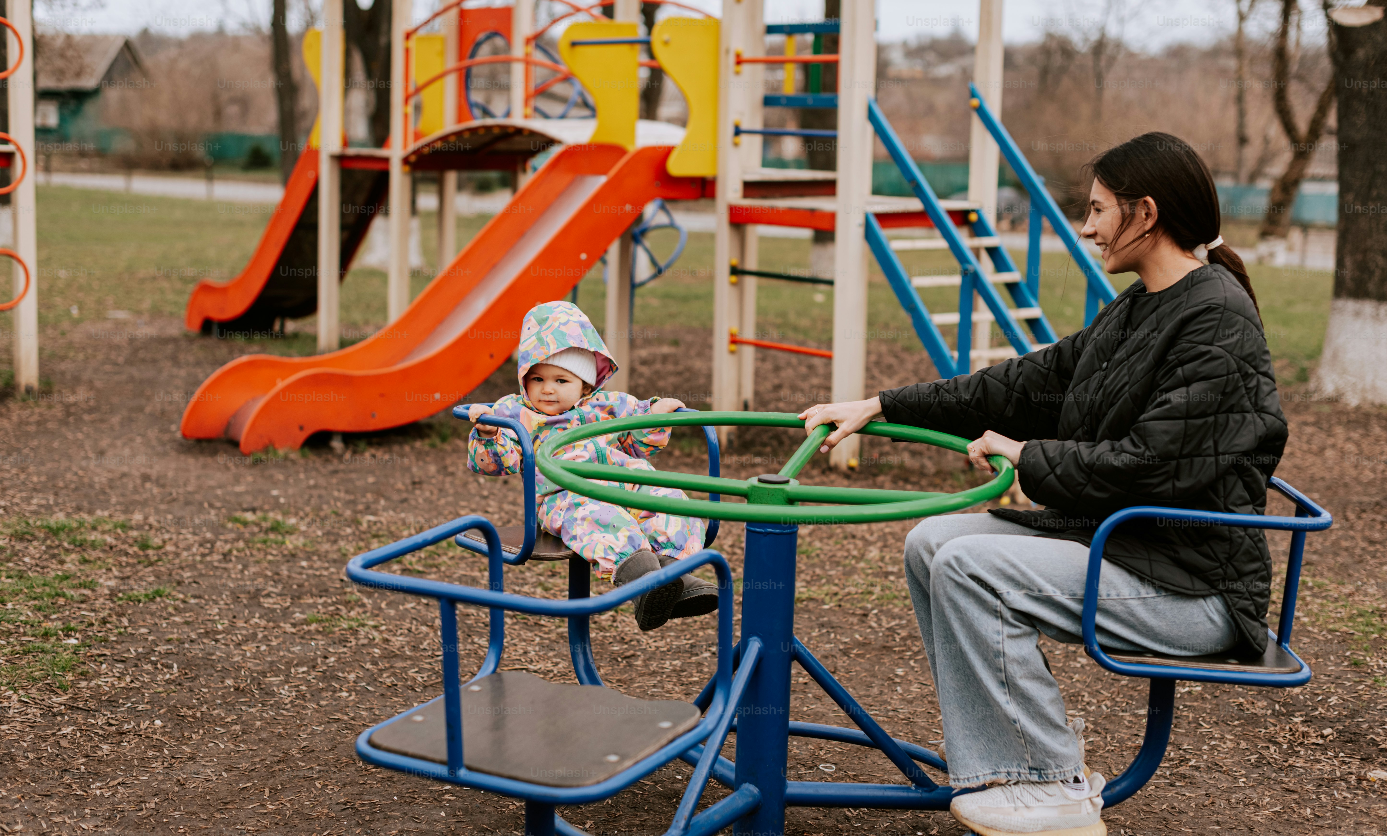 A woman and a baby playing in a park photo – Babysitting Image on Unsplash