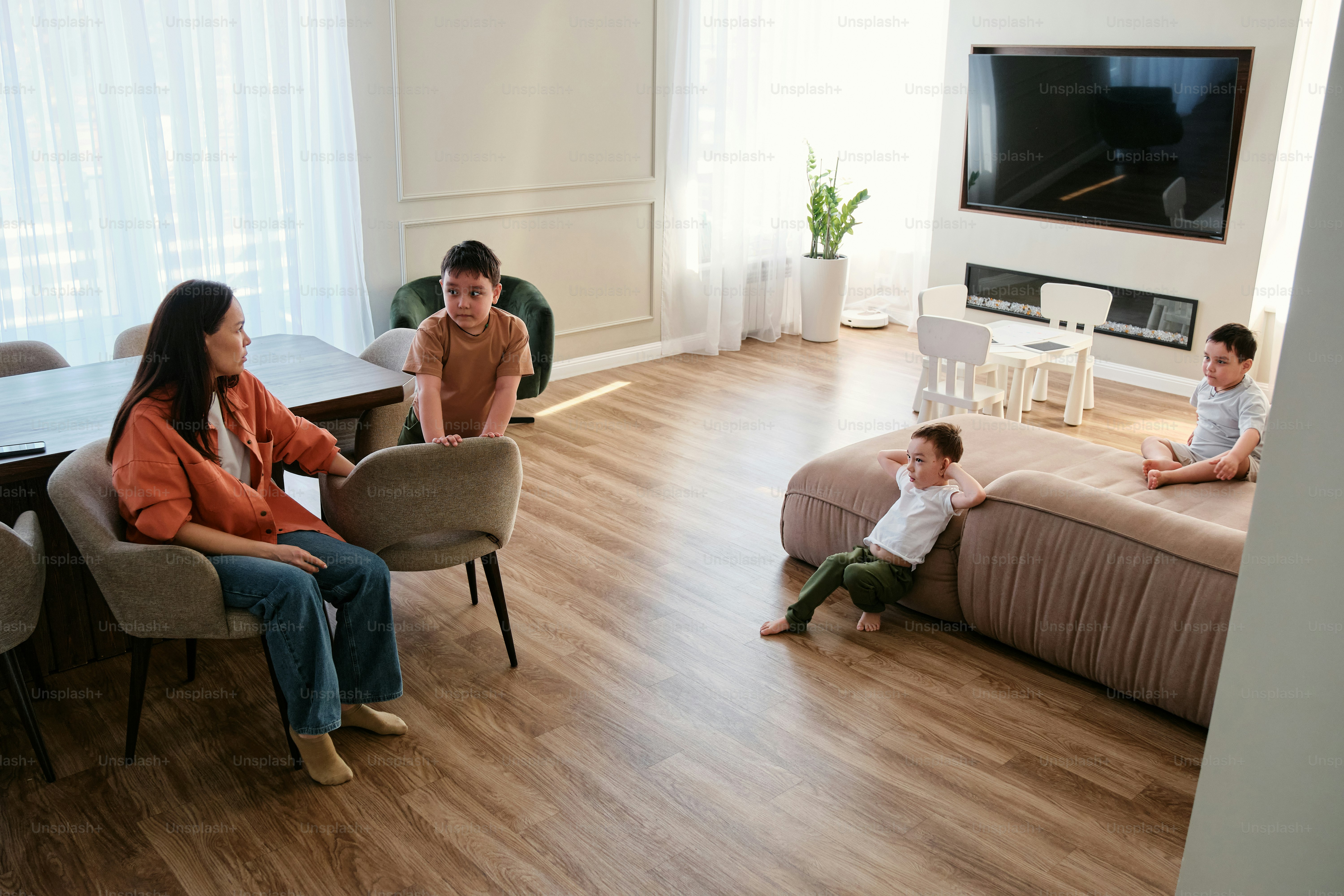 A group of people sitting around a living room photo – Female ...