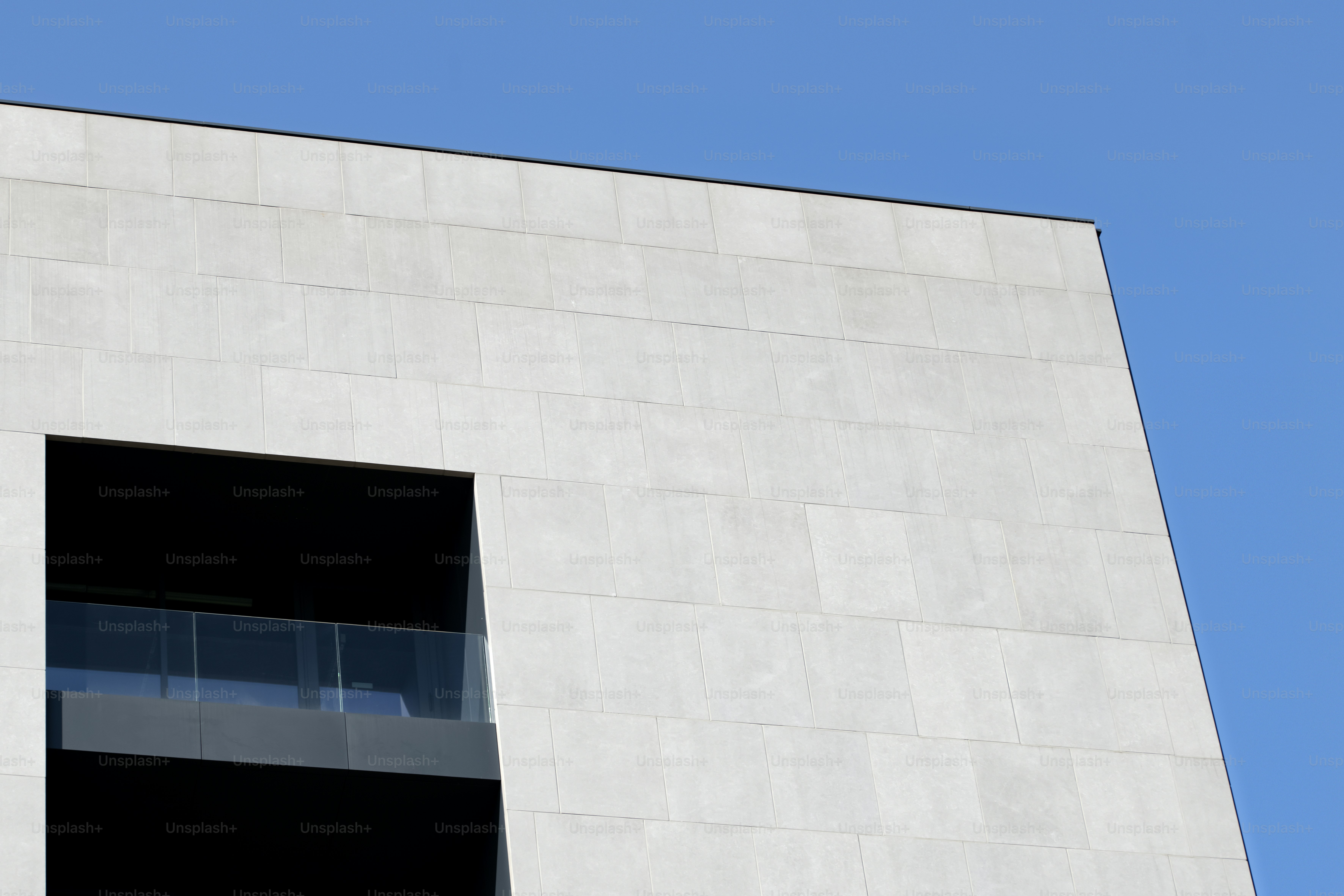 A tall building with a clock on the side of it photo – Minimalist Image ...