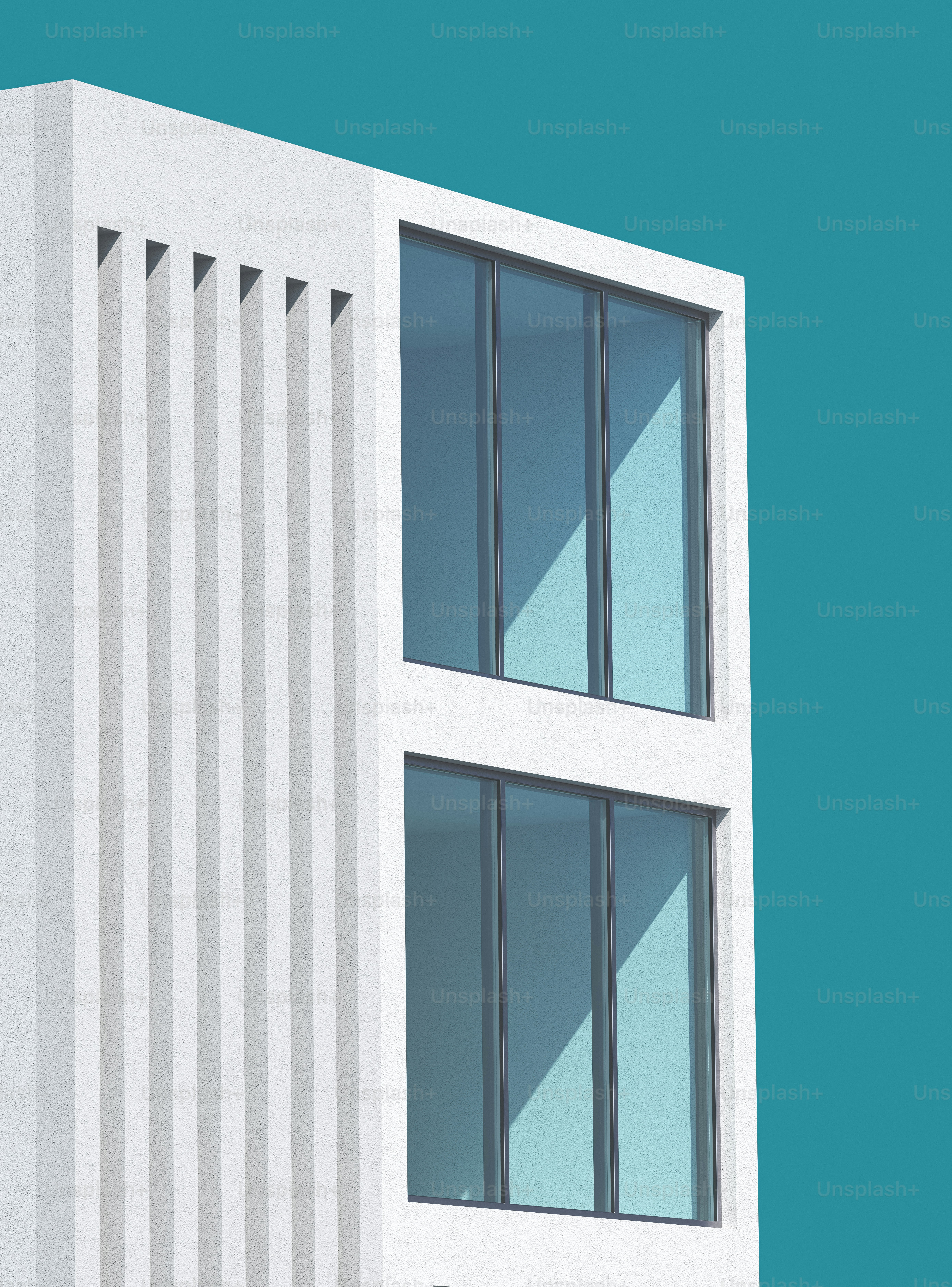 A tall white building with a blue sky in the background photo – Minimal ...