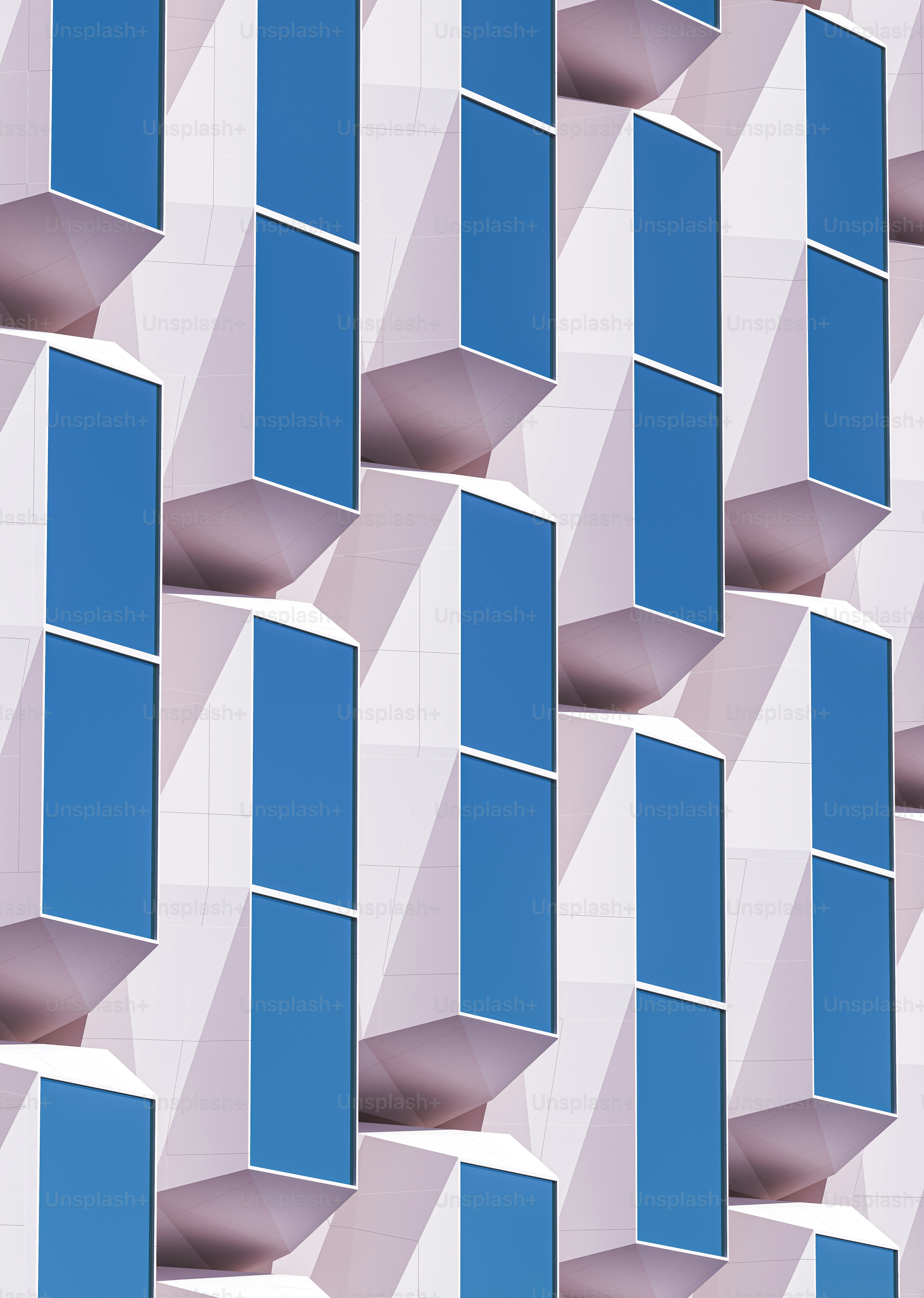 A building that has a bunch of windows on it photo – Vertical wallpaper ...