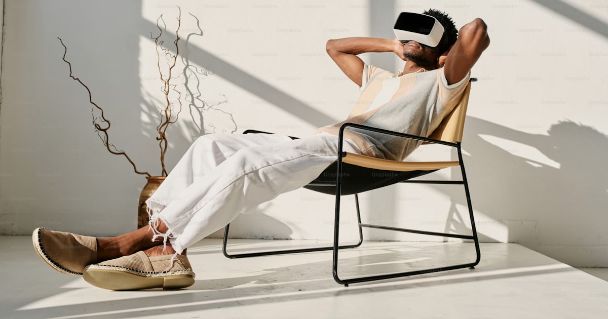 머리에 모자를 쓰고 의자에 앉아 있는 남자 사진 Unsplash의 Vr 헤드셋 이미지